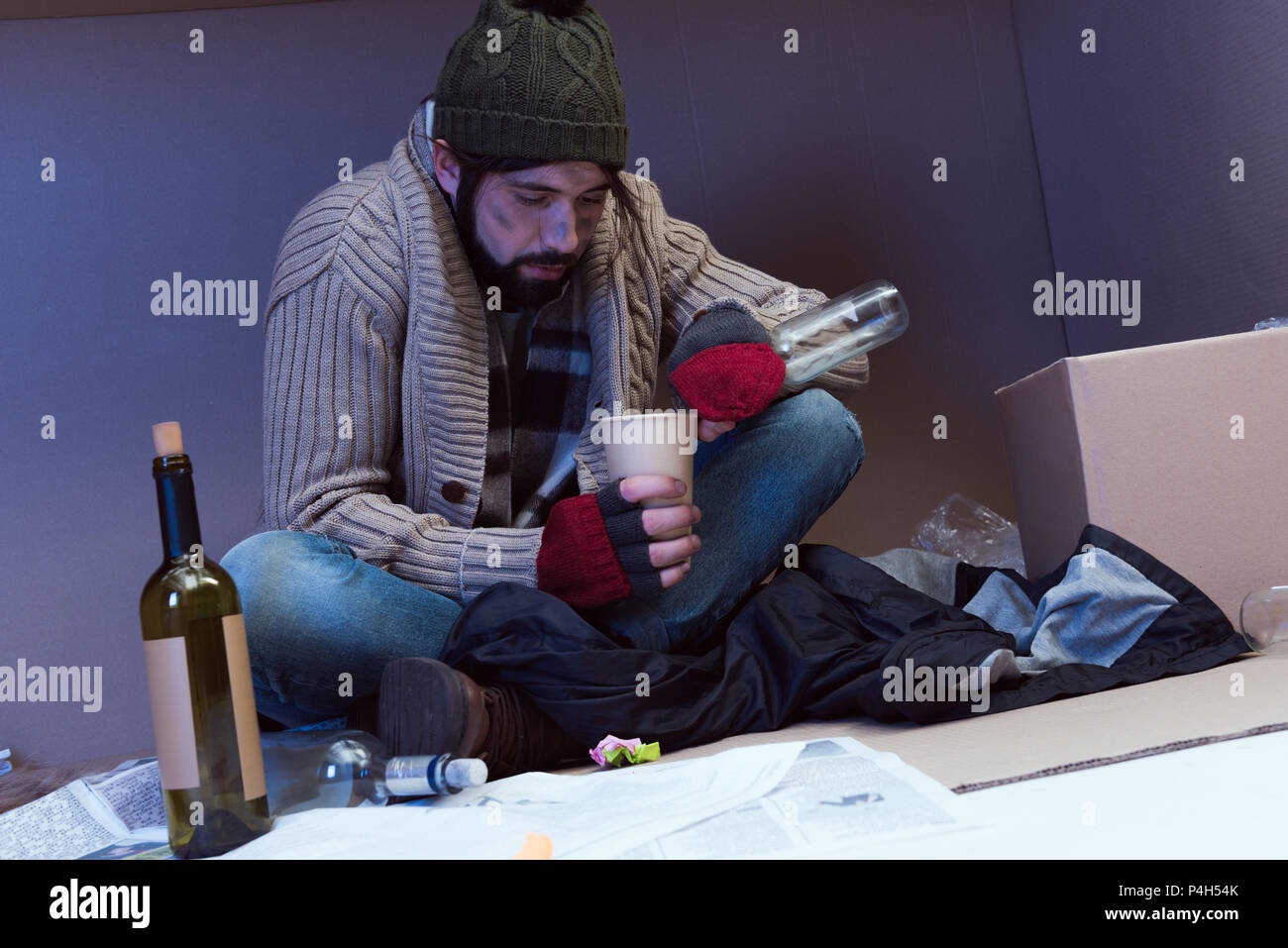 homeless alcoholic drunking in cardboard box Stock Photo - Alamy