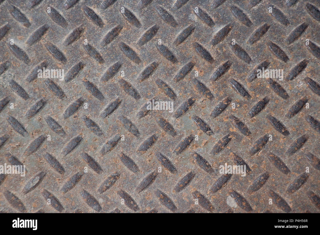 Closeup of distressed, mottled, grungy industrial checker plate rusty ...