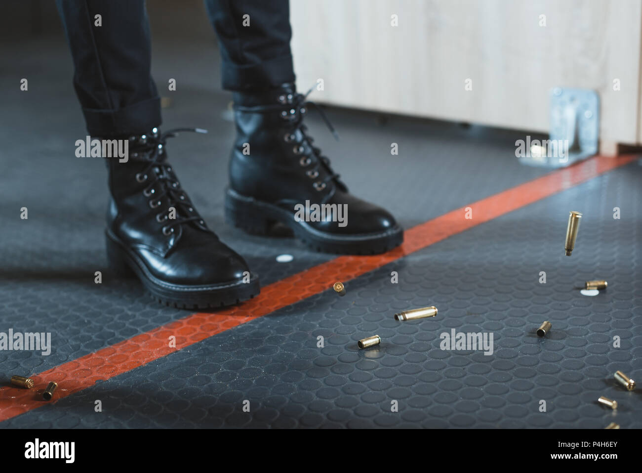 cropped image of woman standing near red line and falling bullets in ...