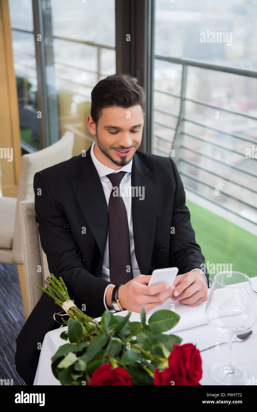 Smiling handsome man waiting girlfriend hi-res stock photography and ...