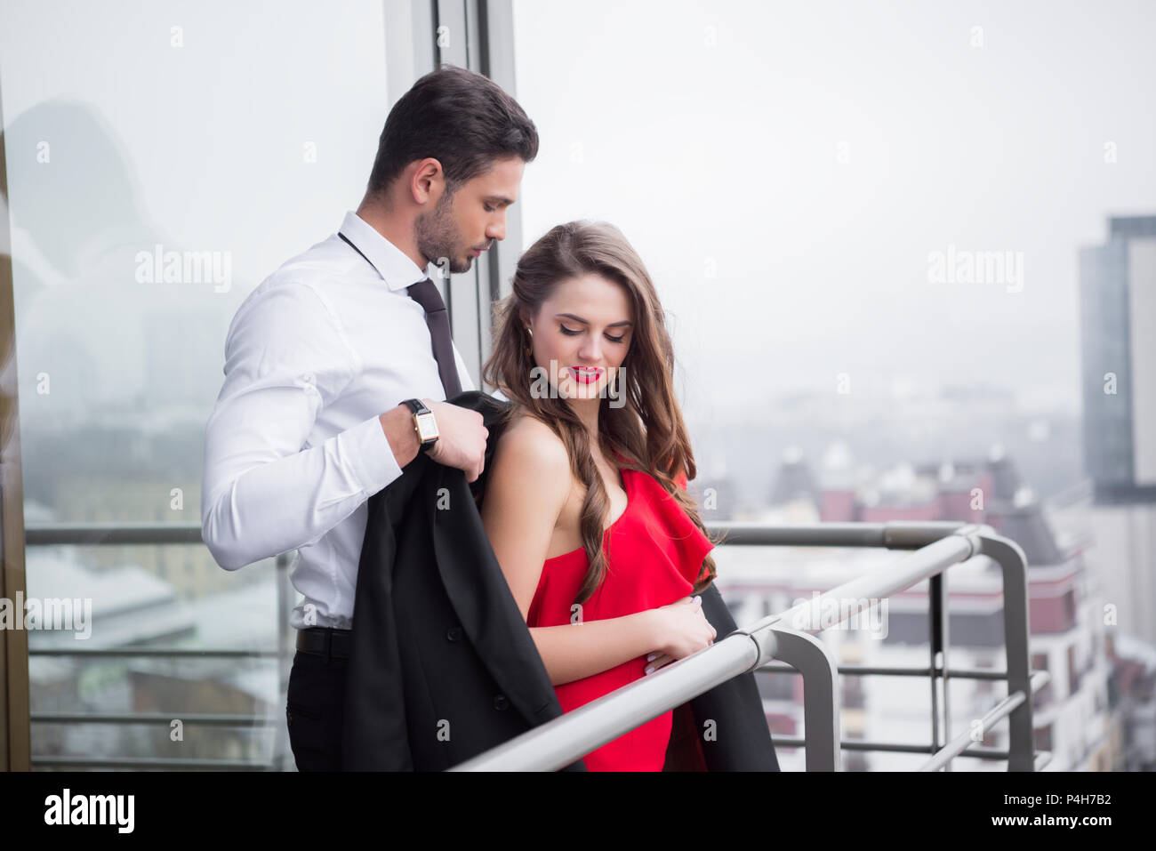 young couple in love standing on balcony together Stock Photo - Alamy