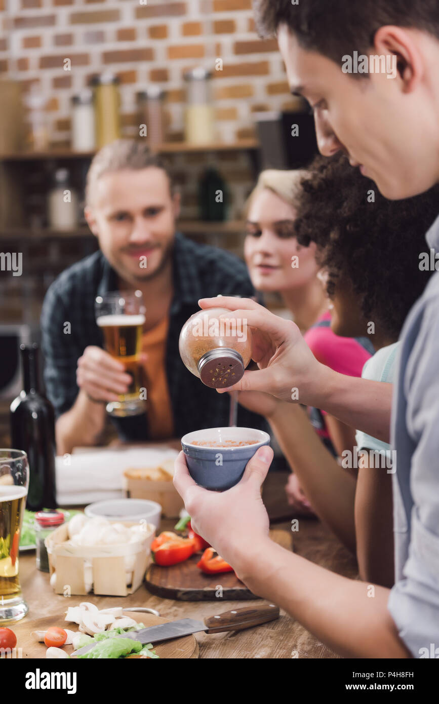 man adding spice to homemade sauce in kitchen Stock Photo - Alamy