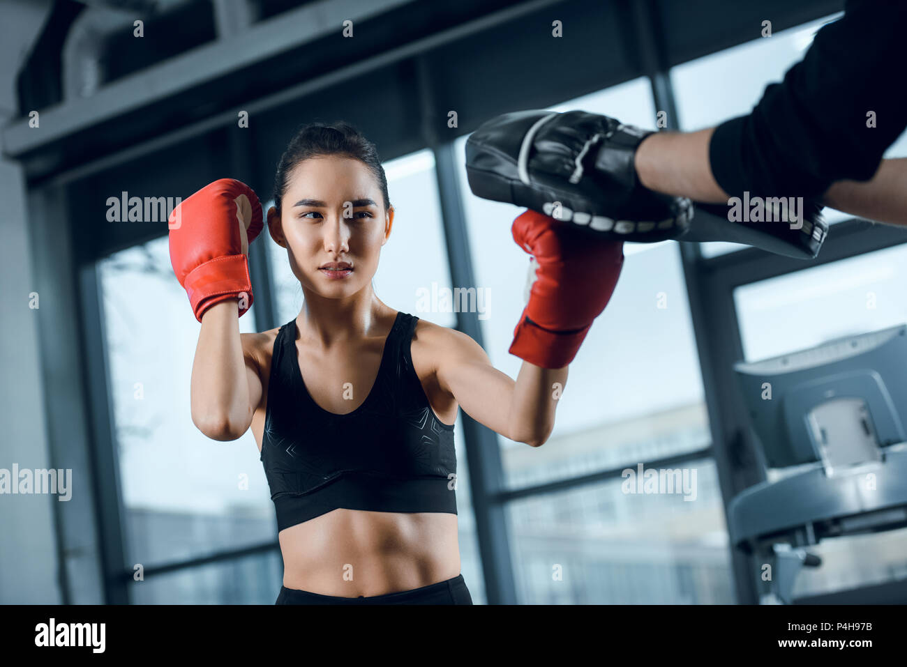 young female boxer exercising with trainer at gym Stock Photo - Alamy