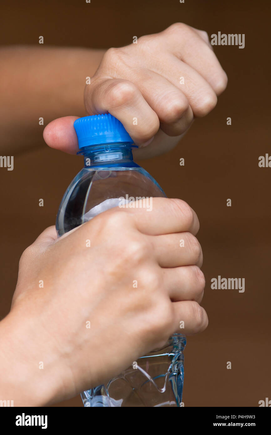 hands opening bottle with fresh clean water on blurred background Stock ...