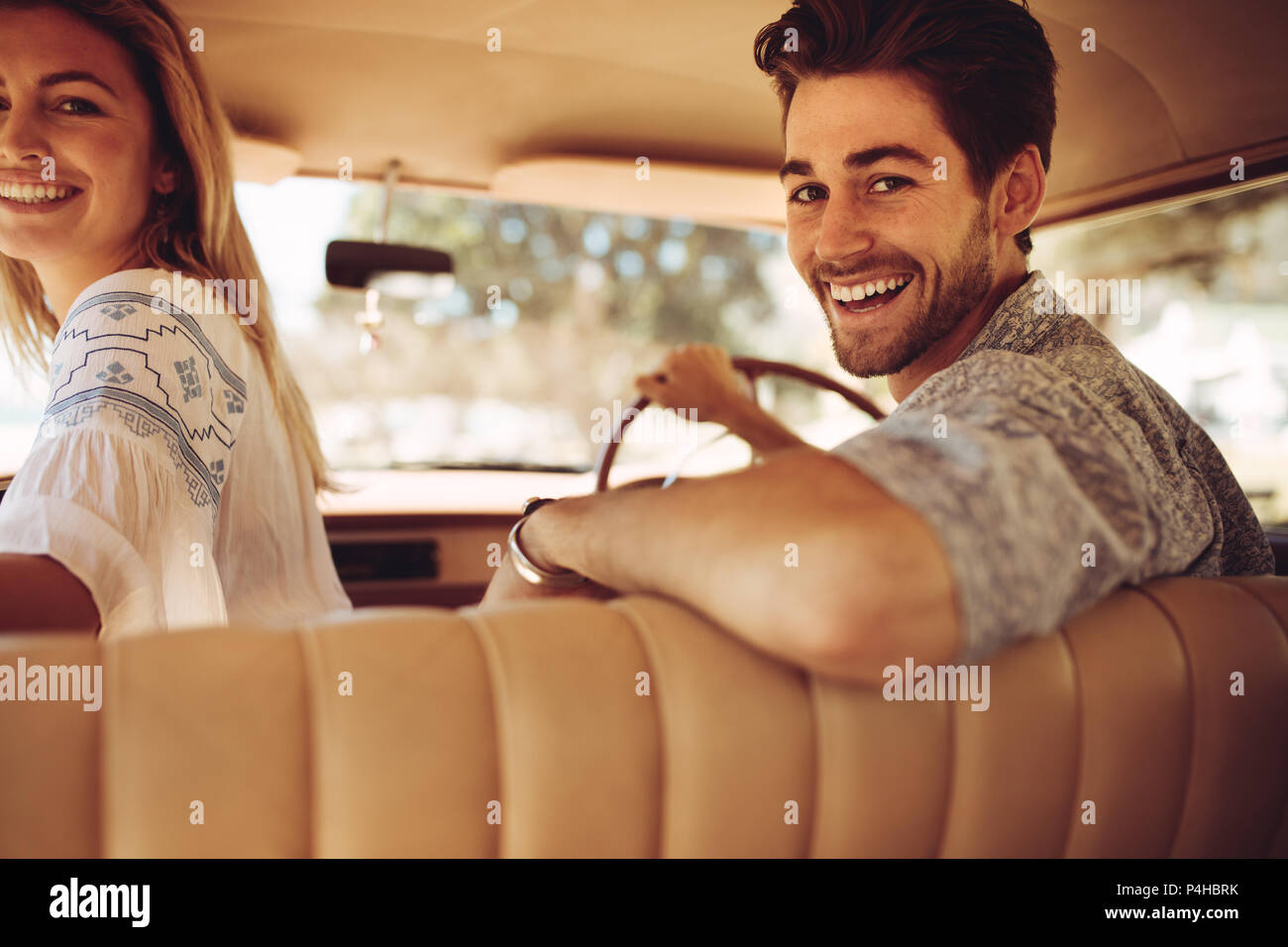 Young couple driving car laughing hi-res stock photography and images ...