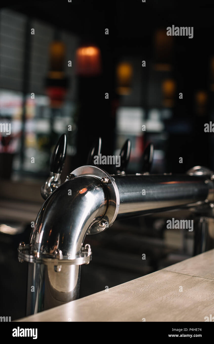 Beer taps at bar counter at the restaurant Stock Photo - Alamy