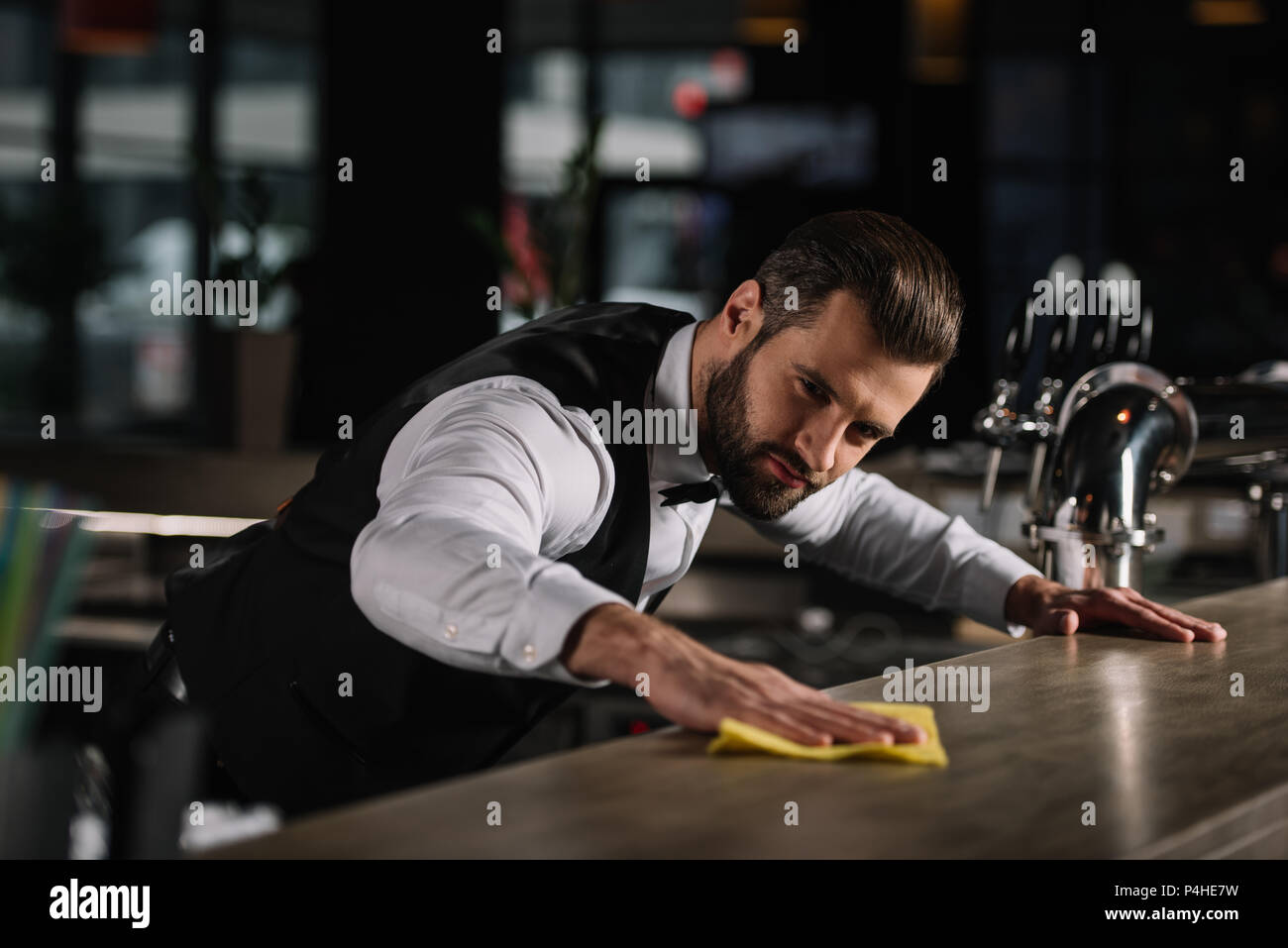 handsome bartender cleaning bar counter in pub Stock Photo - Alamy