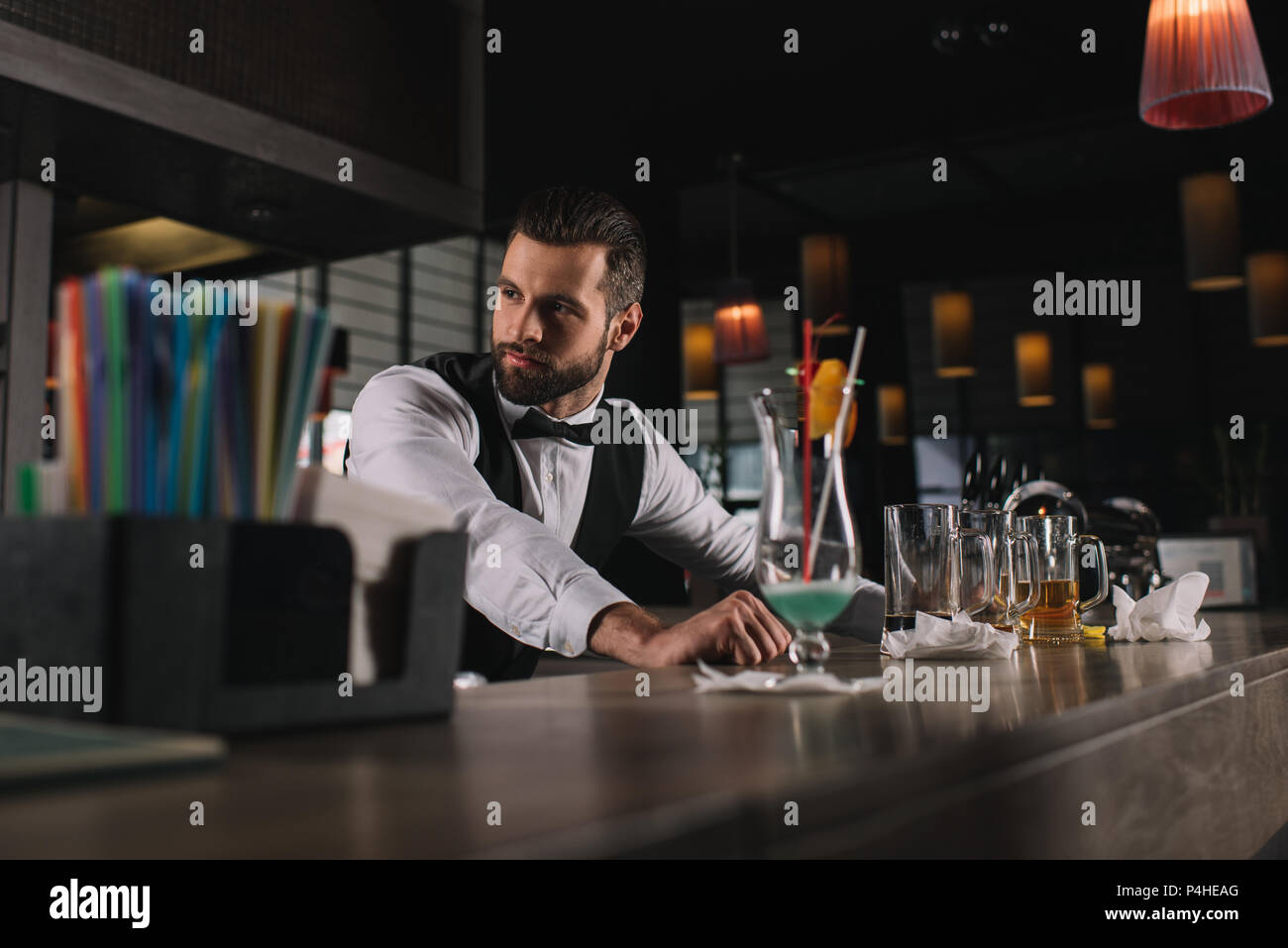 Leaning on bar hi-res stock photography and images - Alamy