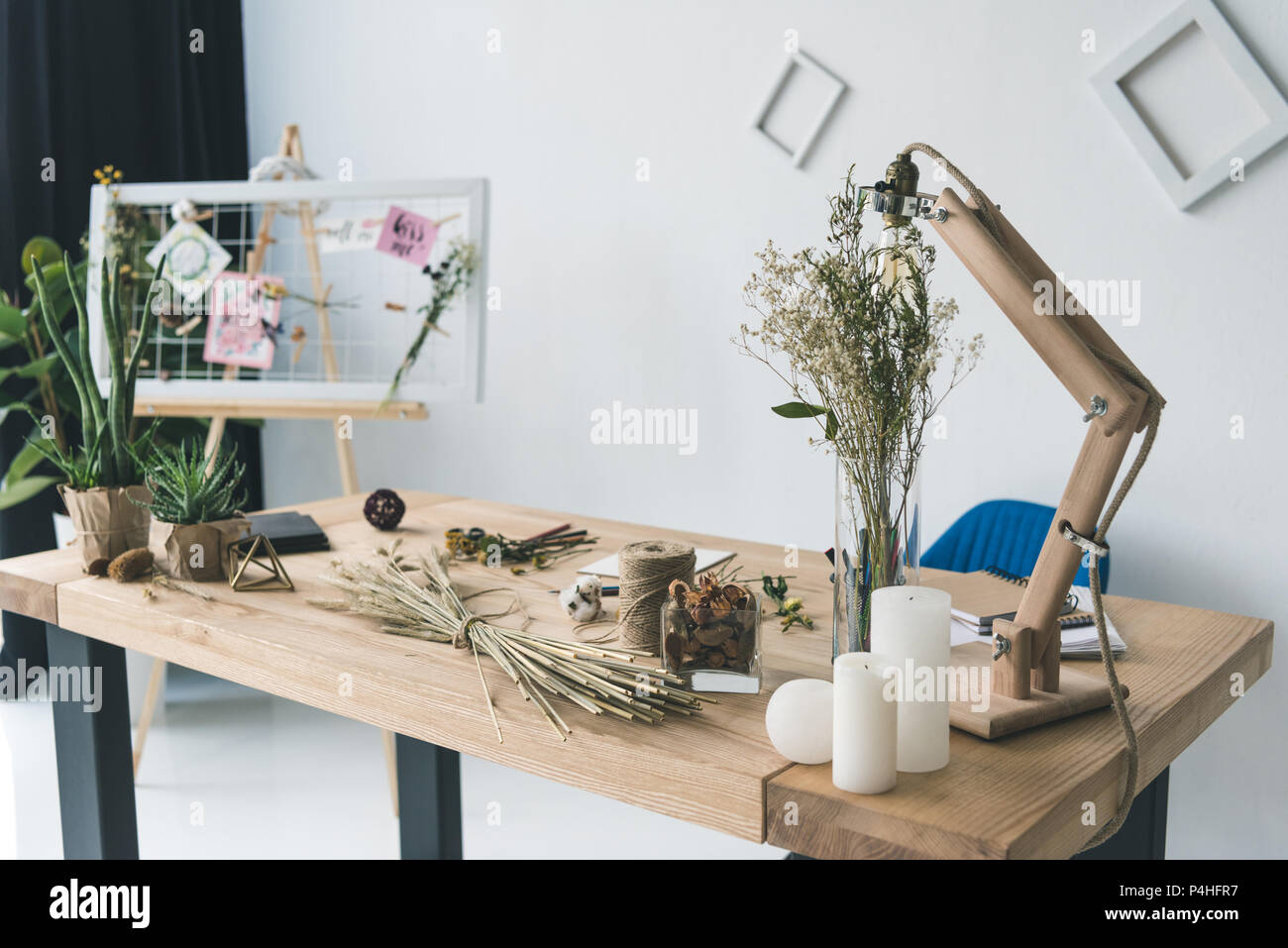 florist workplace with board, dry flowers and wheat ears in modern ...