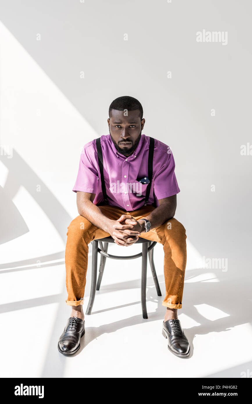 young african american man in stylish clothing with hands in lock ...