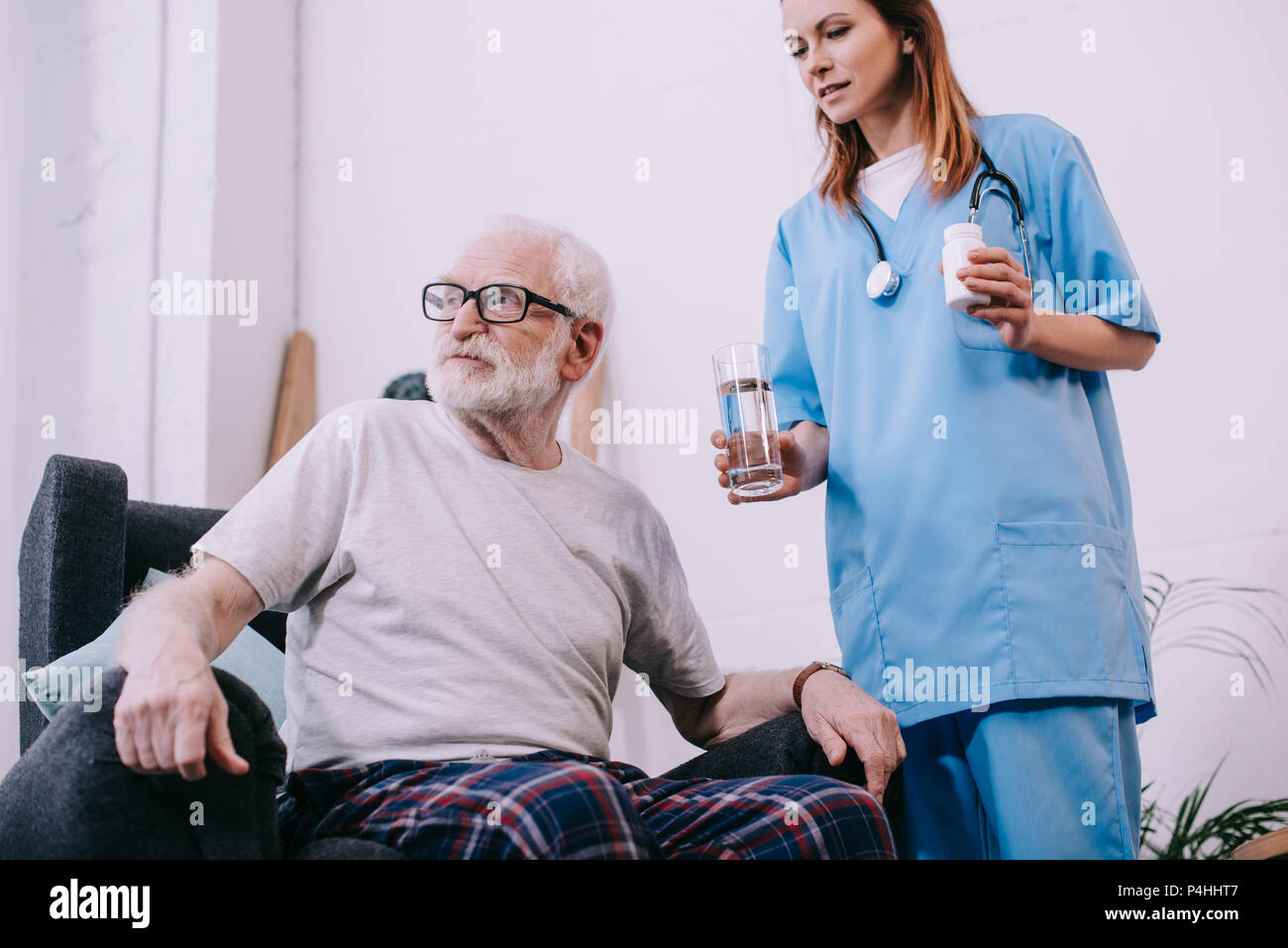 Senior patient refusing to take medications from nurse Stock Photo - Alamy