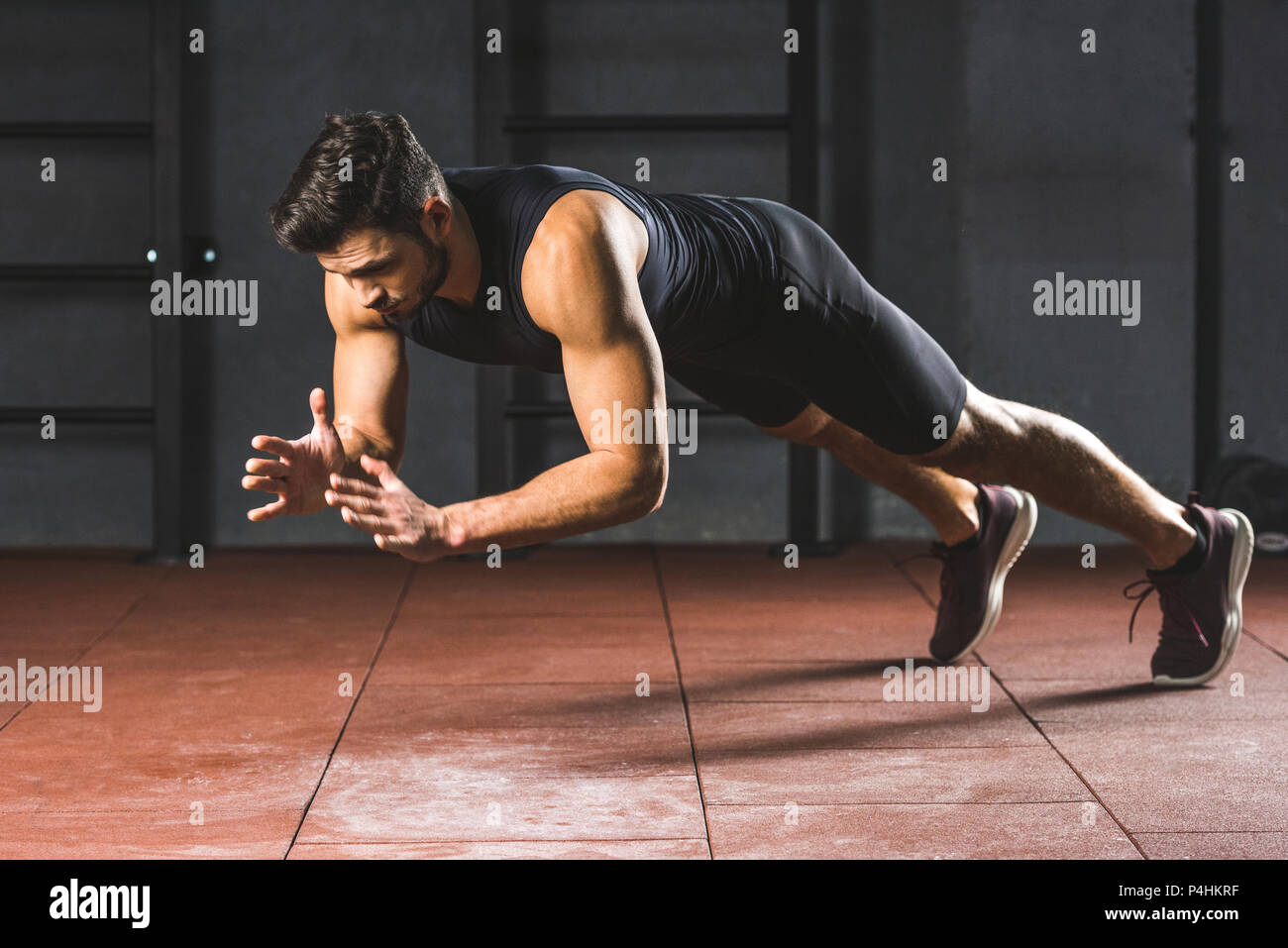Young sportsman doing push ups in sports hall Stock Photo - Alamy