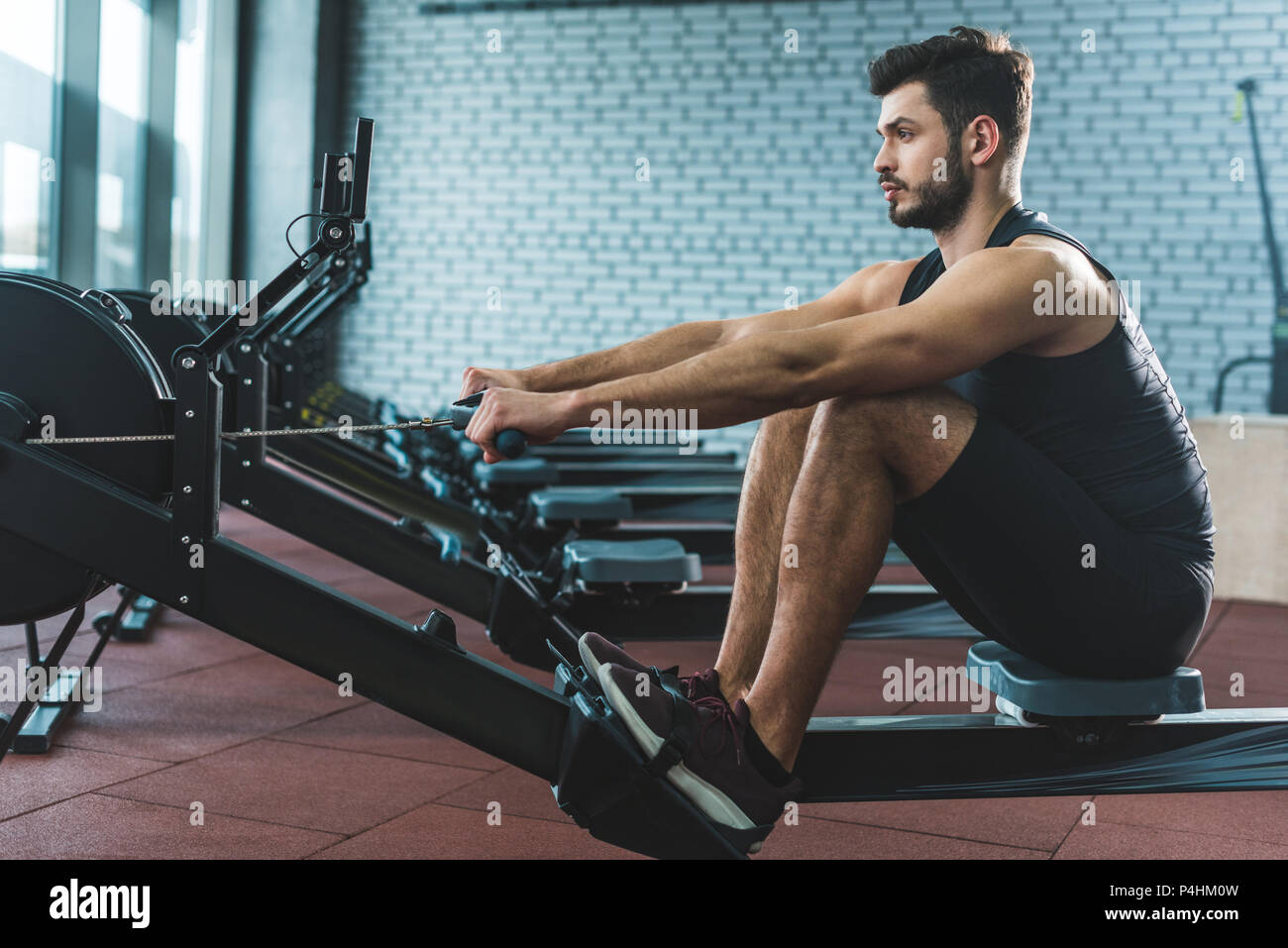 Male on rowing machine hi-res stock photography and images - Alamy