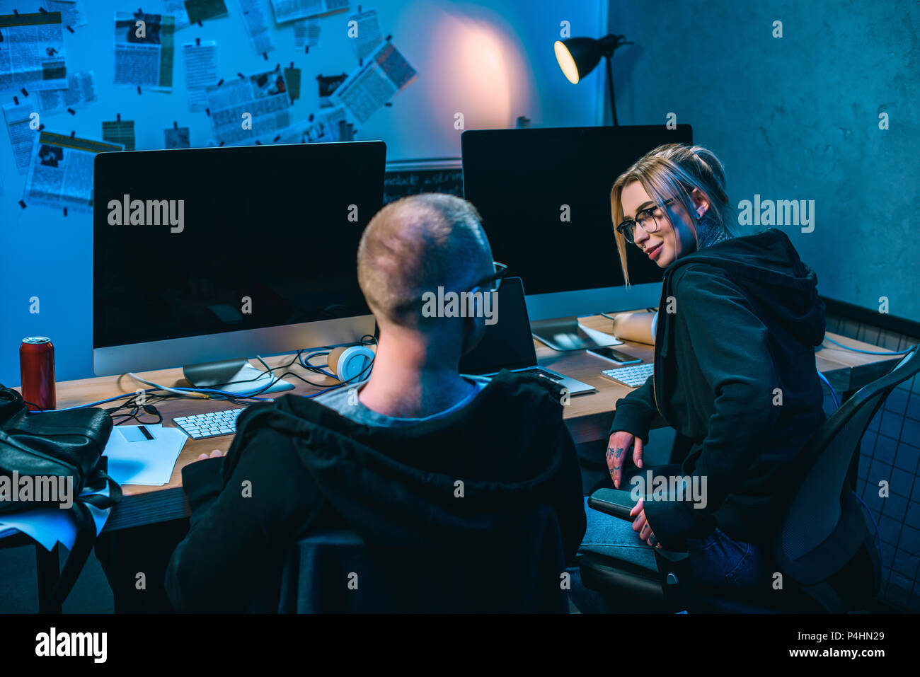 young couple of hackers working on malware together in dark room Stock ...