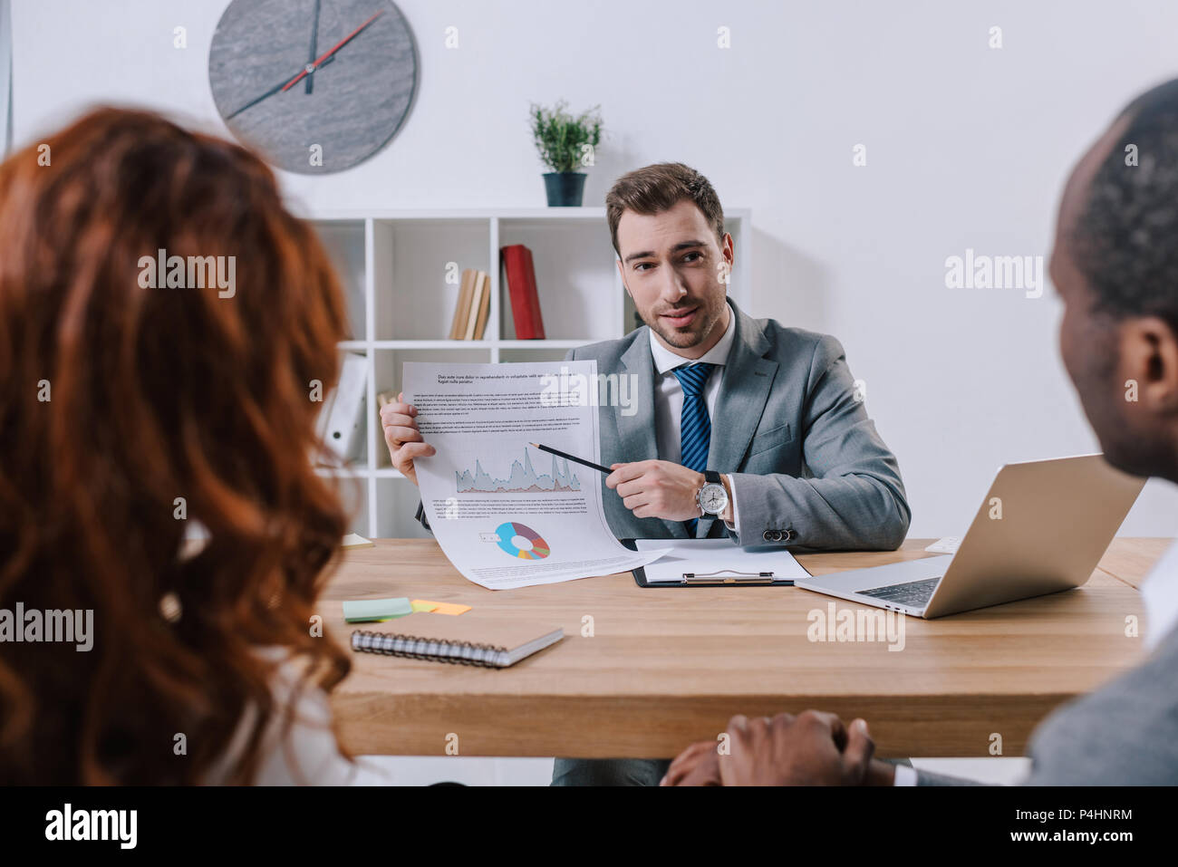 Investment adviser showing presentation to clients Stock Photo - Alamy