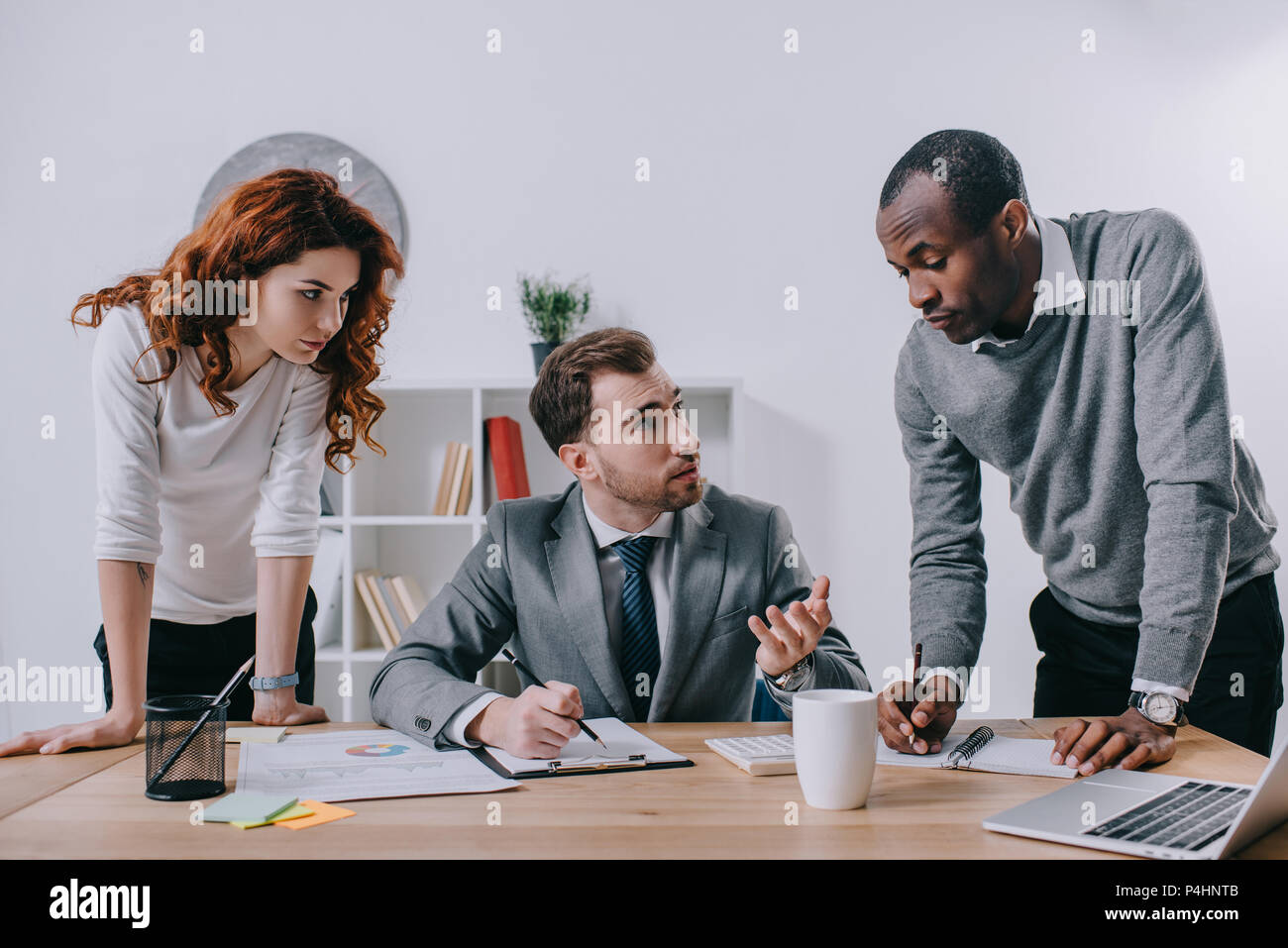 Businessmen doing paperwork together in hi-res stock photography and ...
