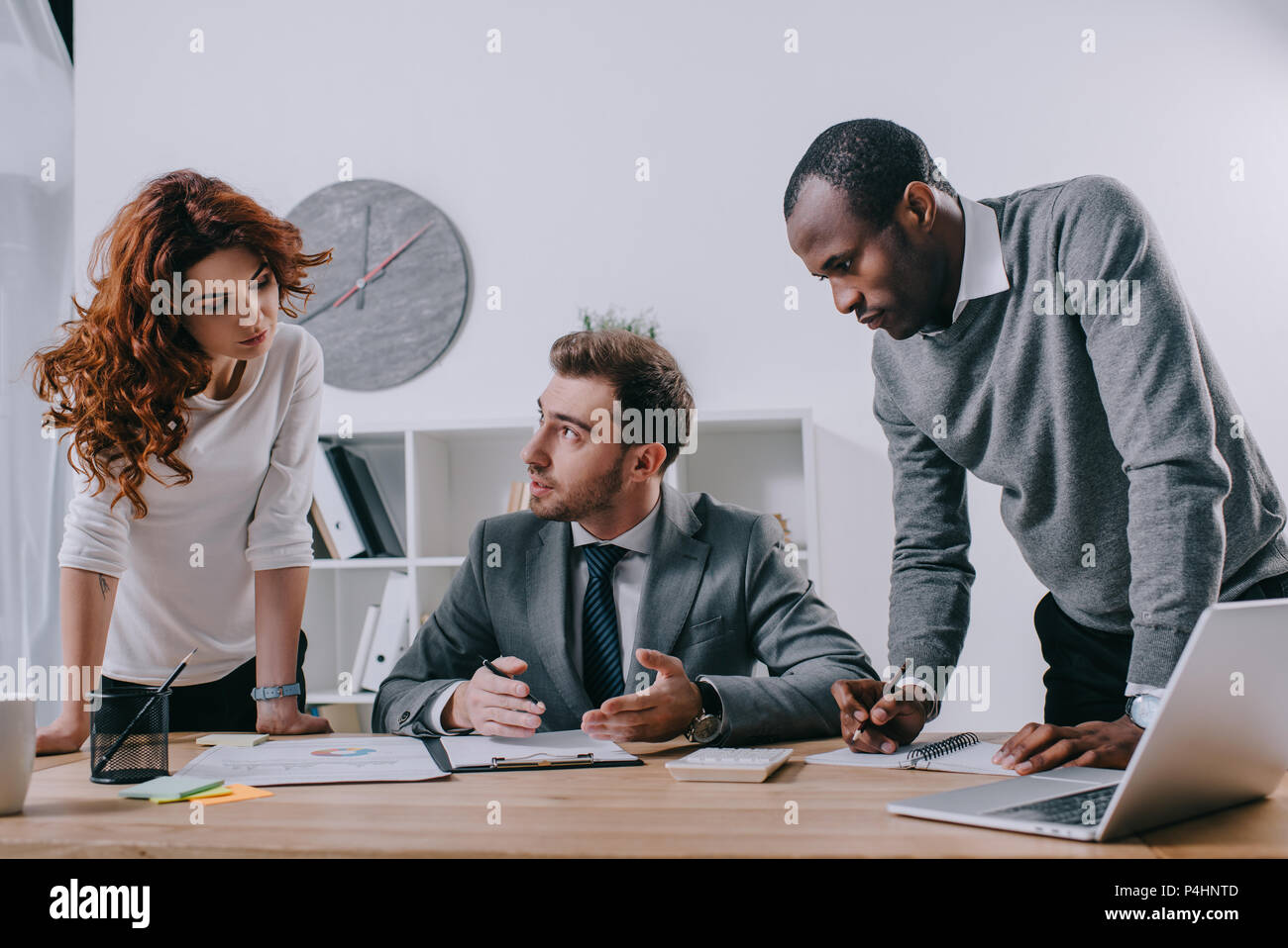Businessmen doing paperwork together in hi-res stock photography and ...