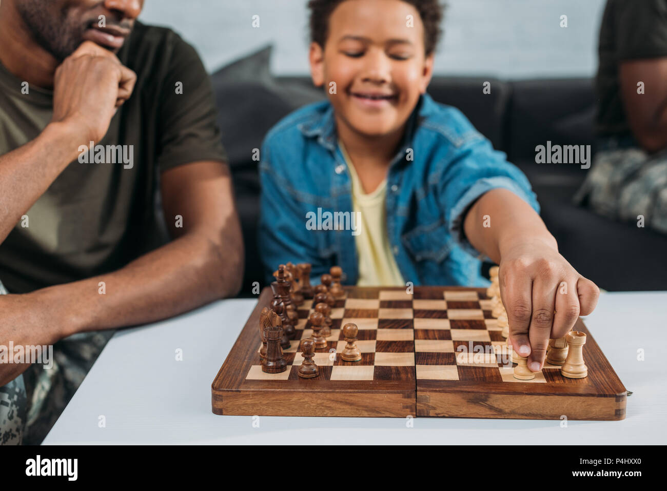 Father in army uniform teaching his son to play chess Stock Photo - Alamy