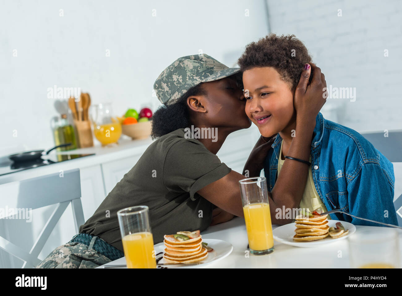 African american soldier with son enjoying meal in kitchen Stock Photo ...