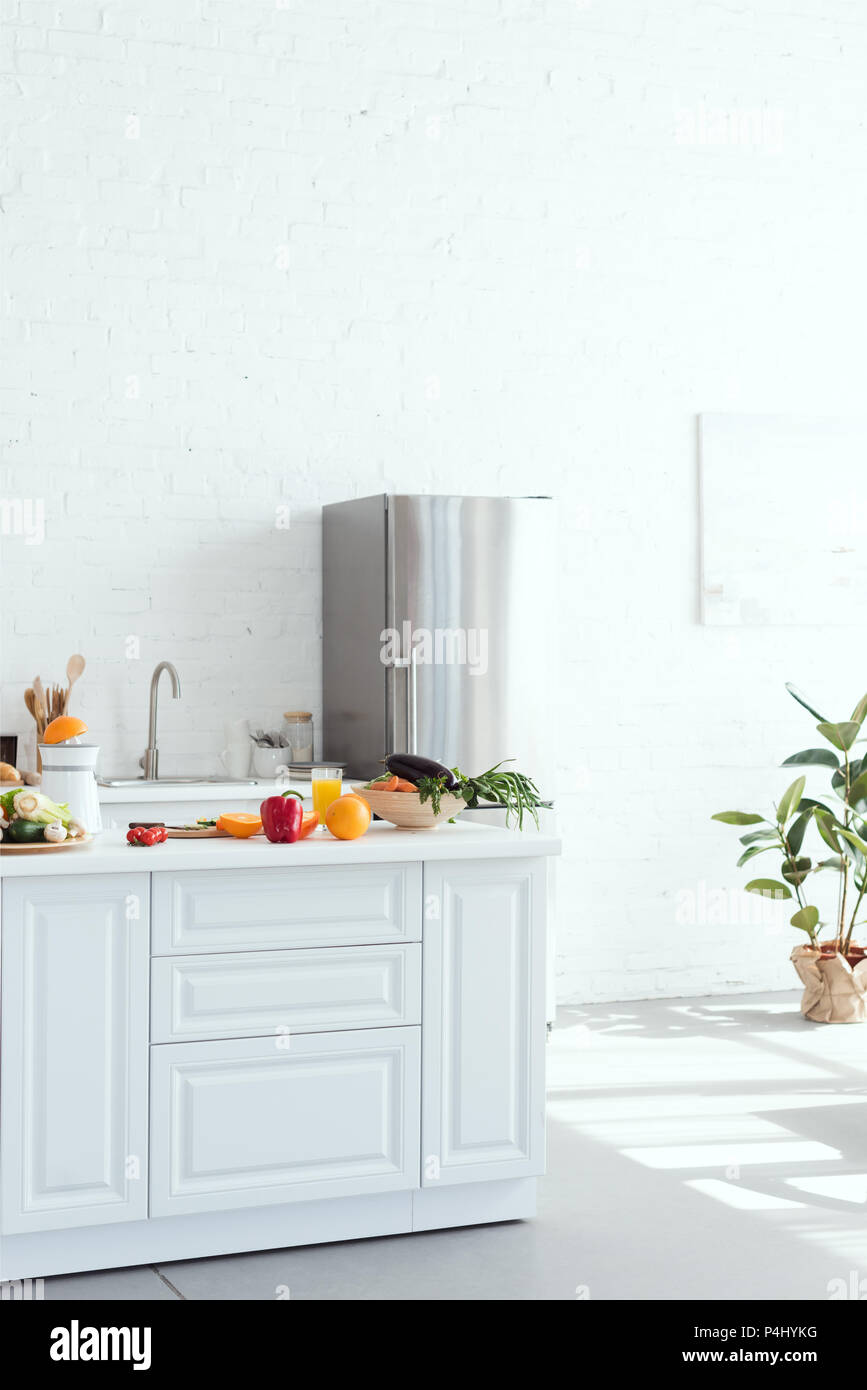 interior of light modern kitchen with fruits and vegetables on kitchen ...