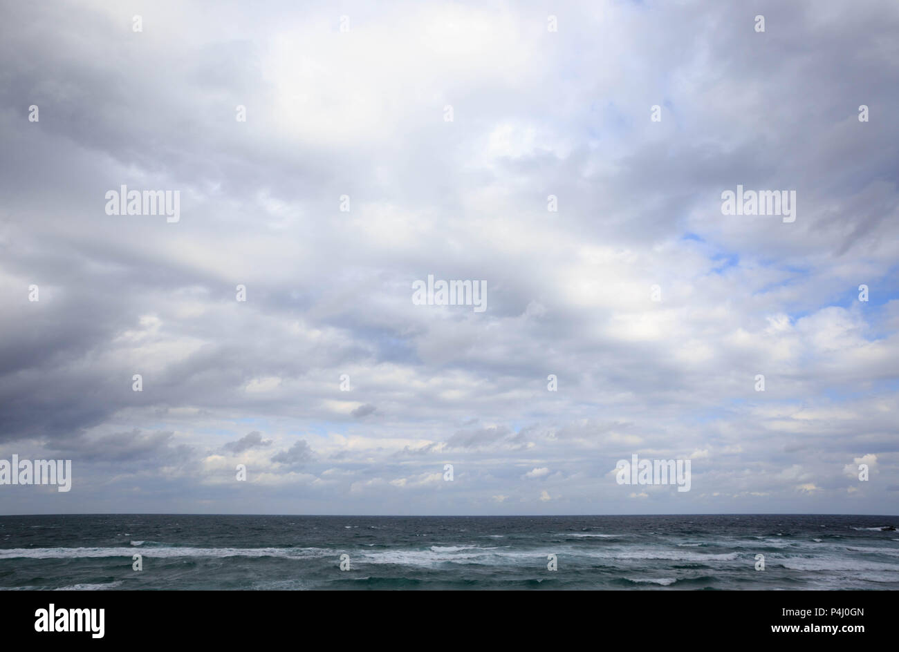 Cloudy sky over windswept choppy ocean with view to horizon Stock Photo ...