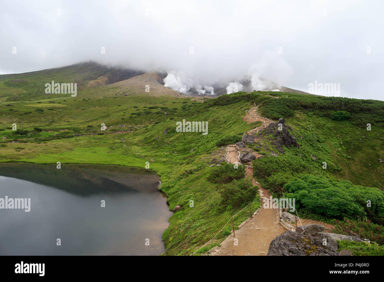 Narrow dirt path leading to steam vents on Asahidake, an active volcano ...