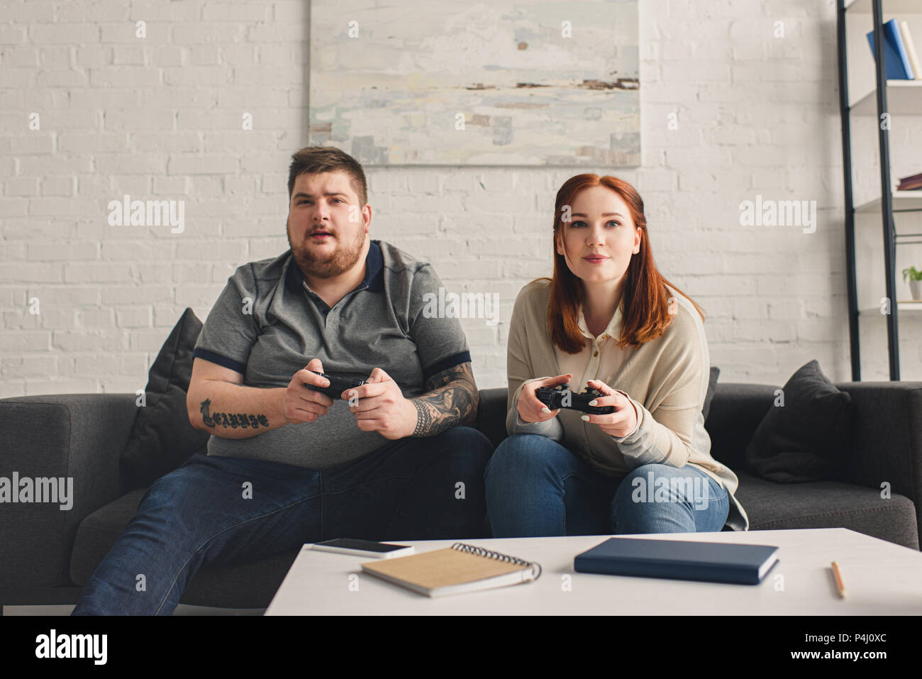 boyfriend and girlfriend playing video game at home Stock Photo - Alamy
