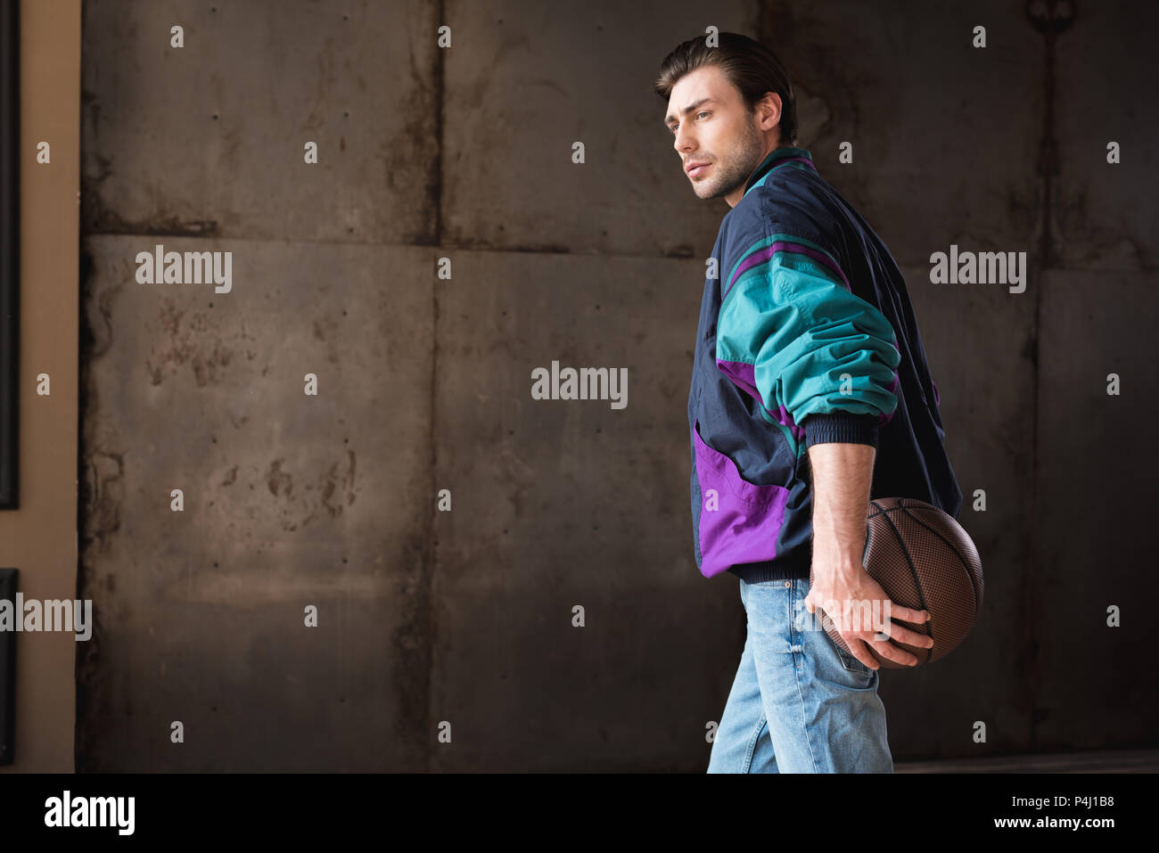 serious young man in vintage windcheater with basketball ball Stock ...