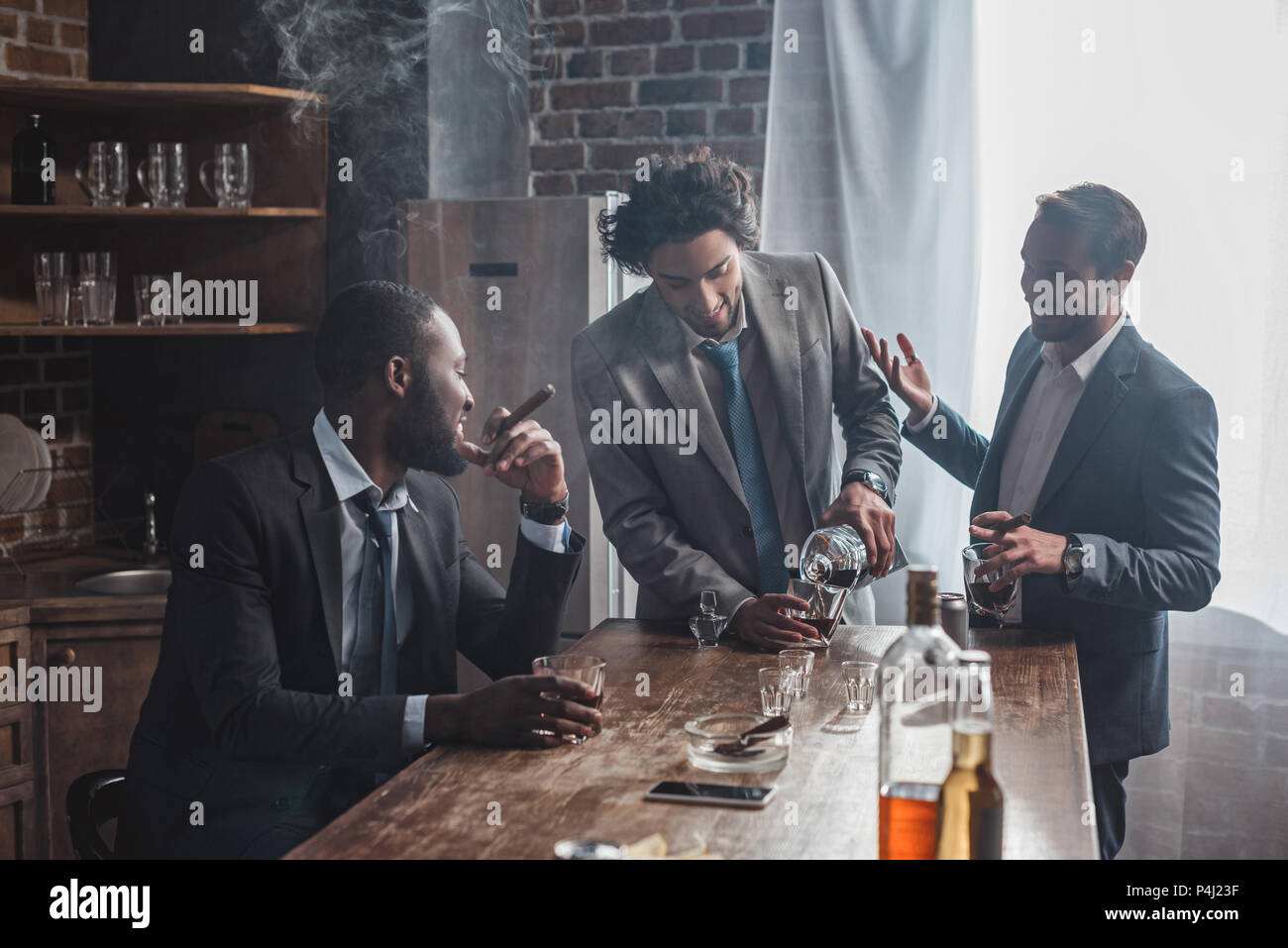 male friends talking while drinking alcohol and smoking cigars Stock ...