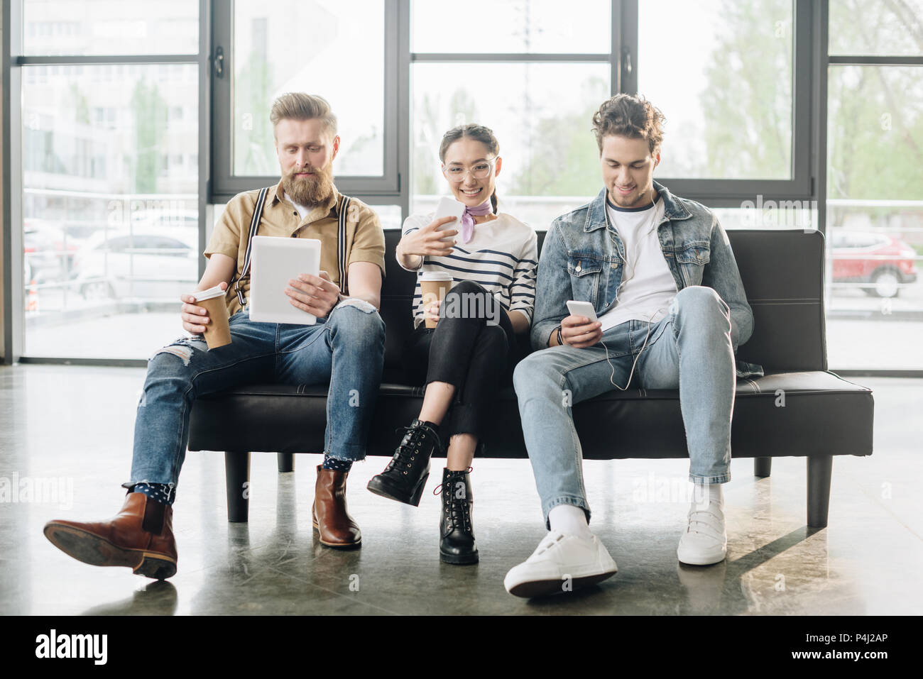 Successful business people using gadgets in modern light office Stock ...