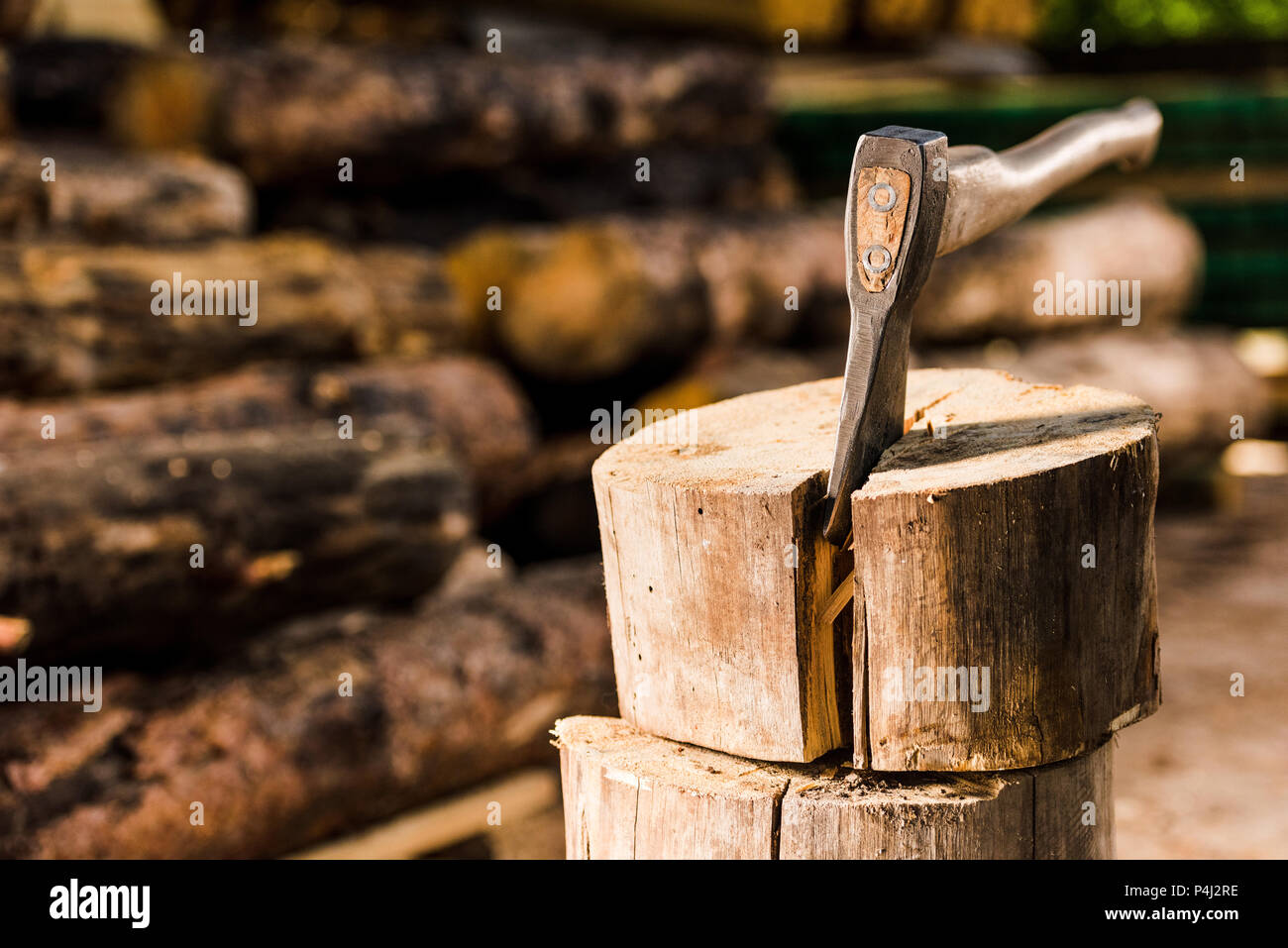 closeup view of sticking axe in log at sawmill Stock Photo - Alamy