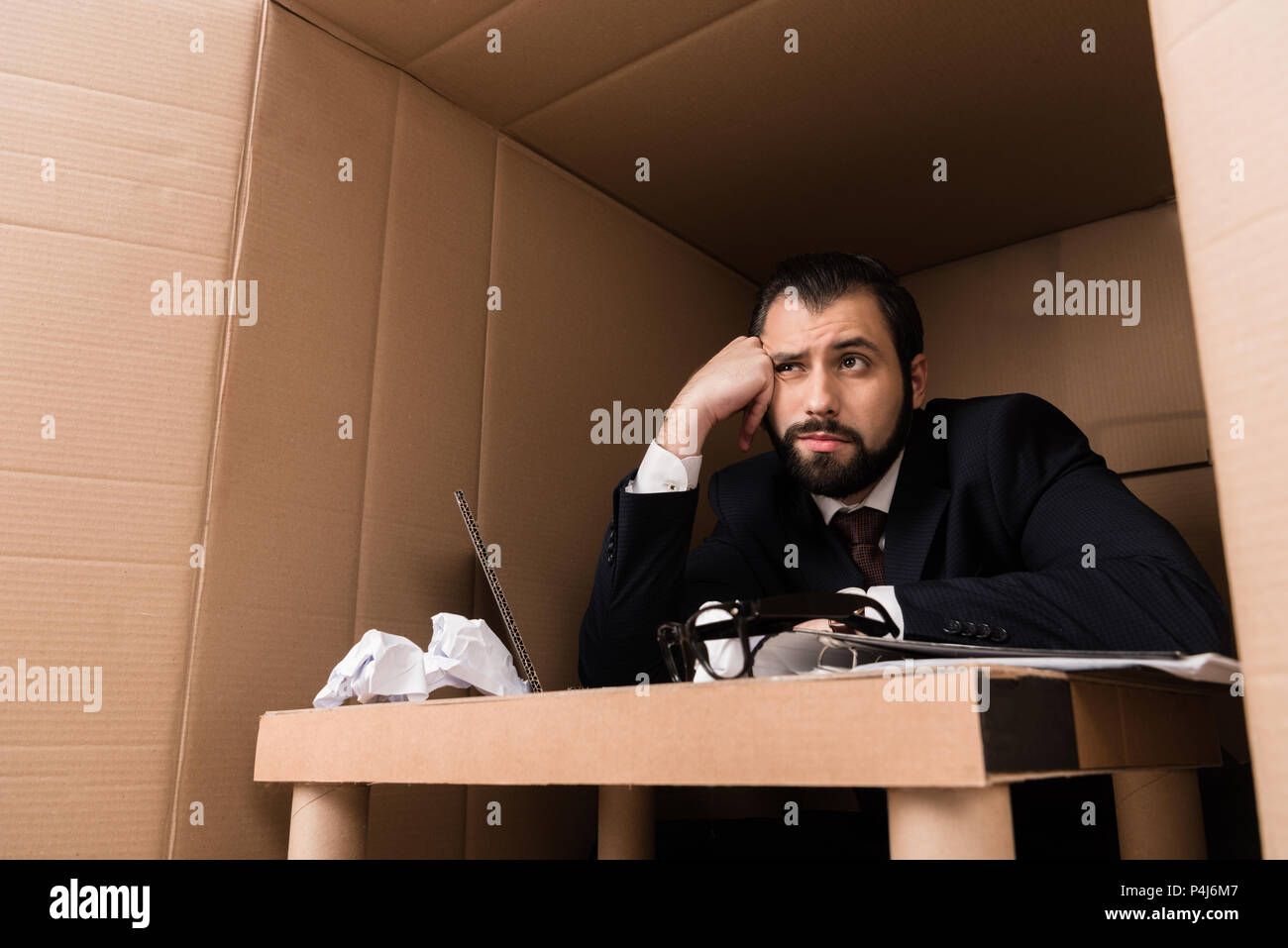 bored businessman working with cardboard laptop in box Stock Photo - Alamy