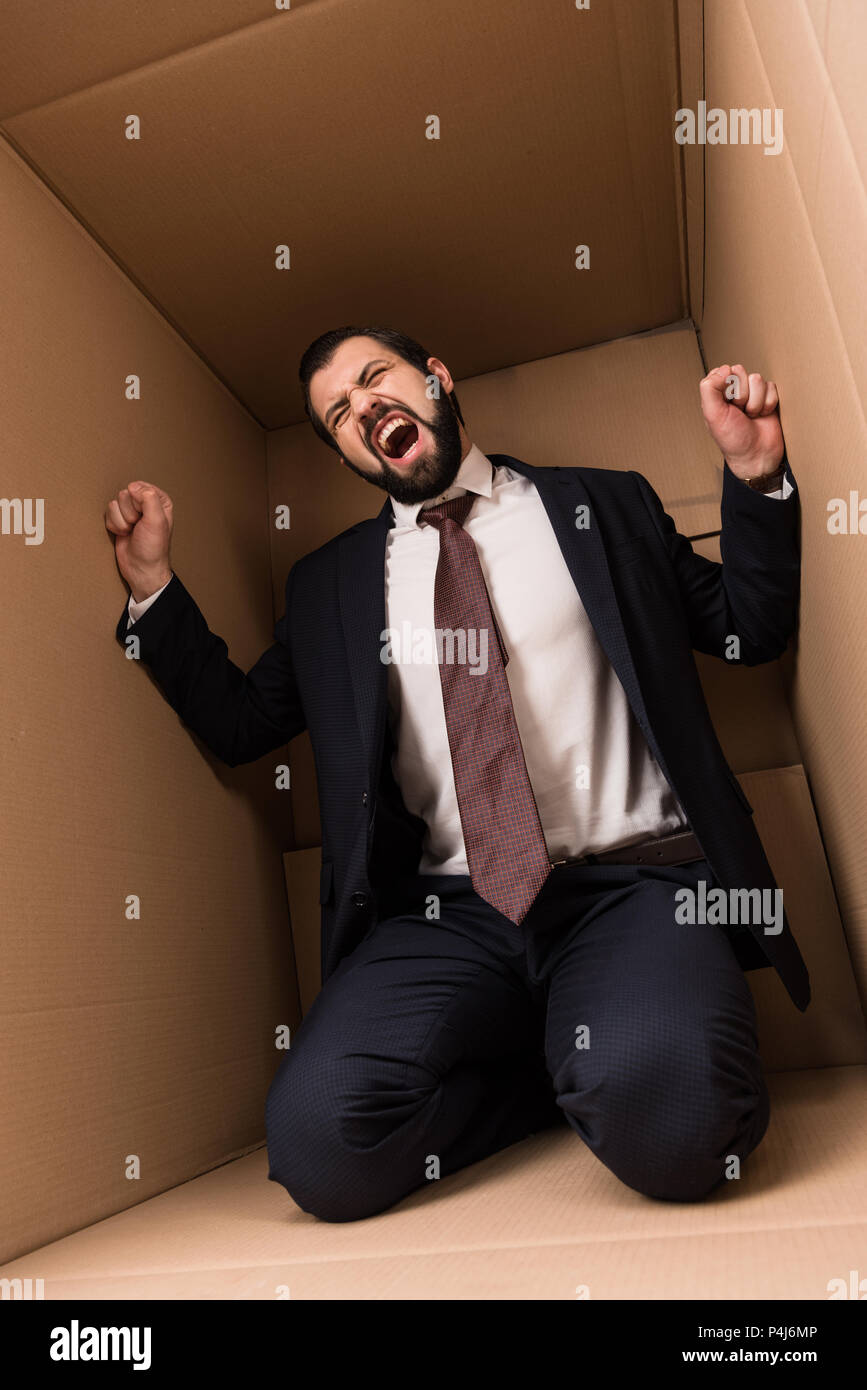 Handsome male in suit kneeling hi-res stock photography and images - Alamy