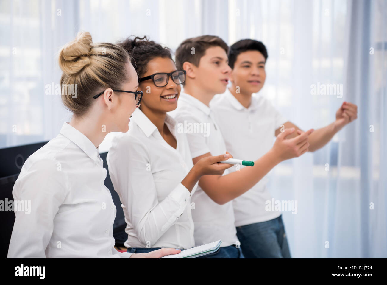 young multicultural students looking and pointing on something Stock ...