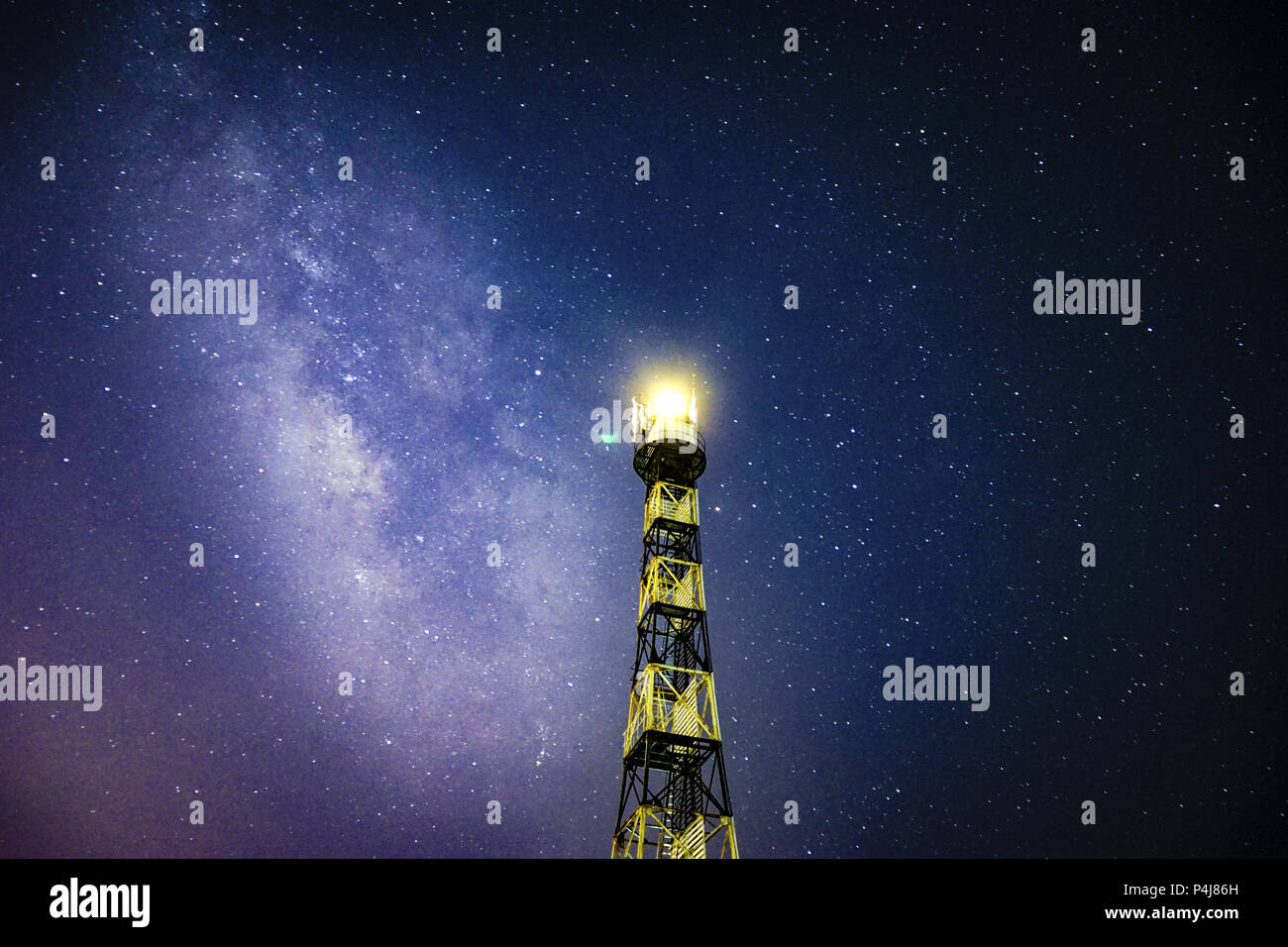 lighthouse under the galaxy Stock Photo - Alamy