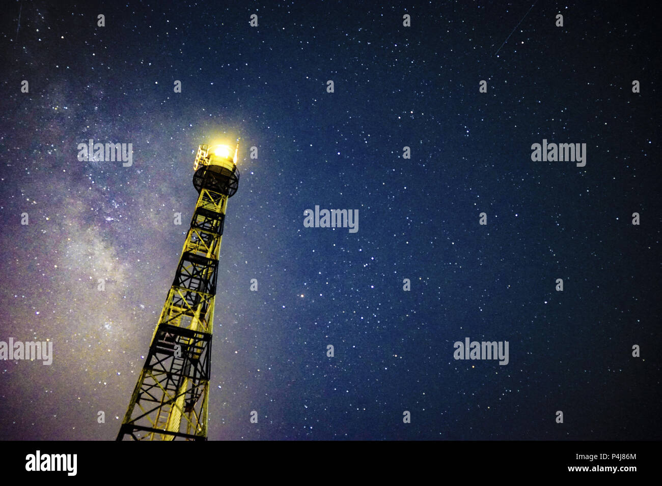 lighthouse under the galaxy Stock Photo - Alamy