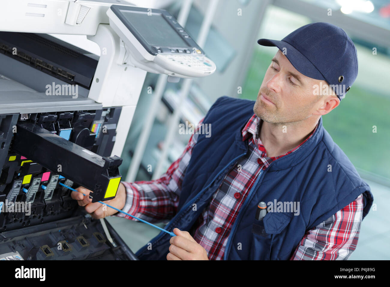 Contractor servicing photocopier Stock Photo - Alamy