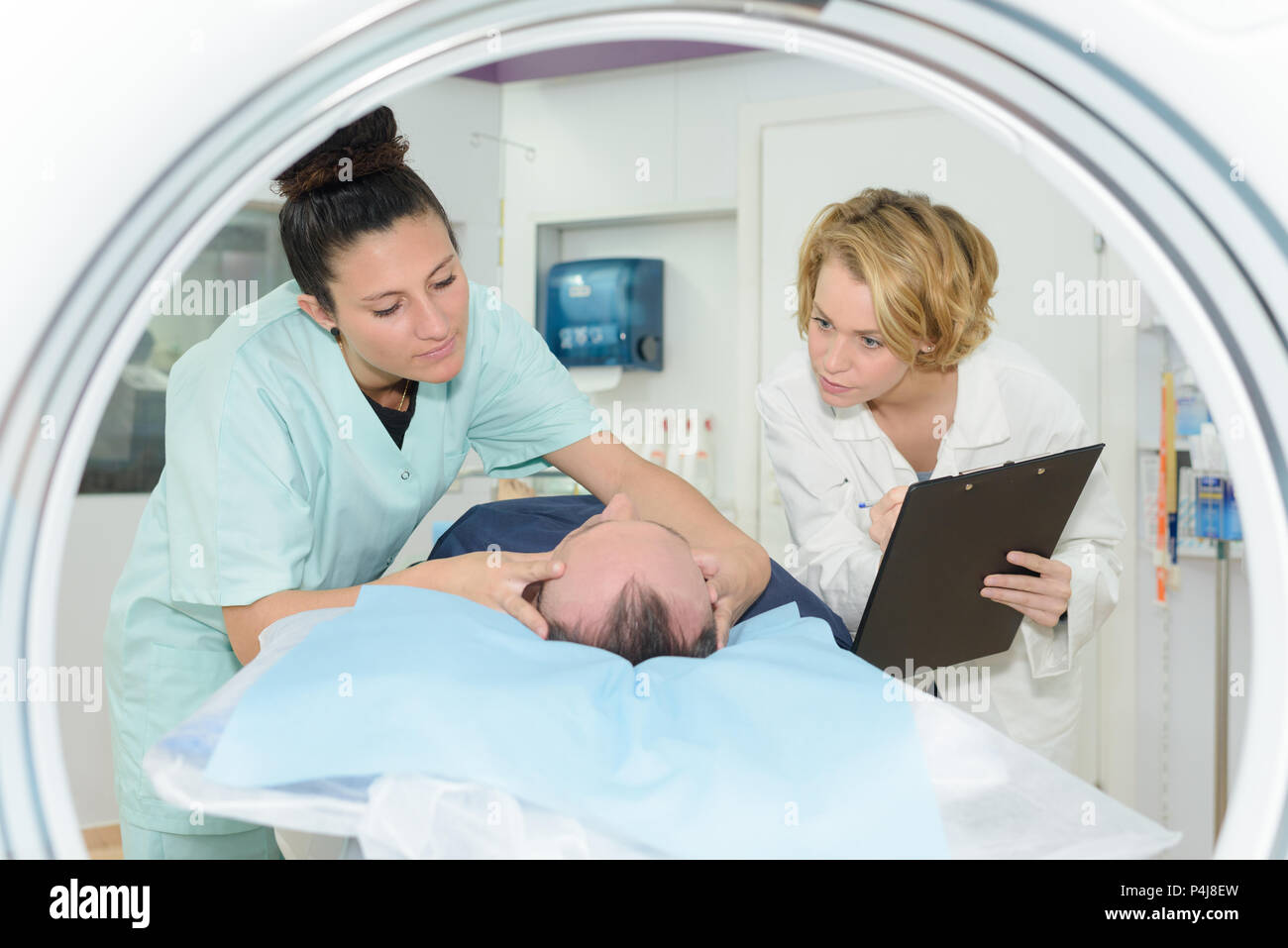 view from mri scanner of nurses tending patient Stock Photo - Alamy
