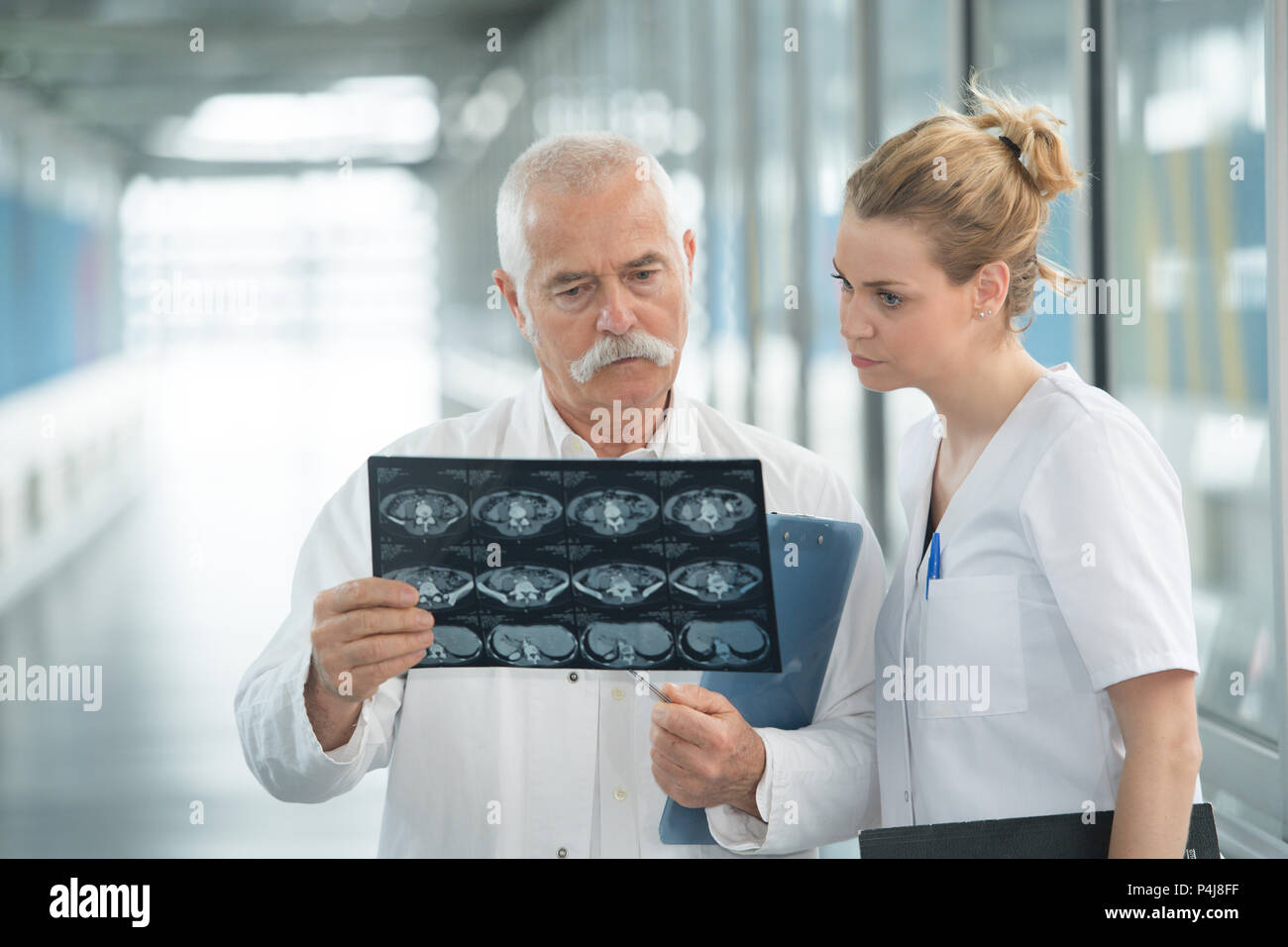 senior male radiologist reviewing x-ray with colleague Stock Photo - Alamy