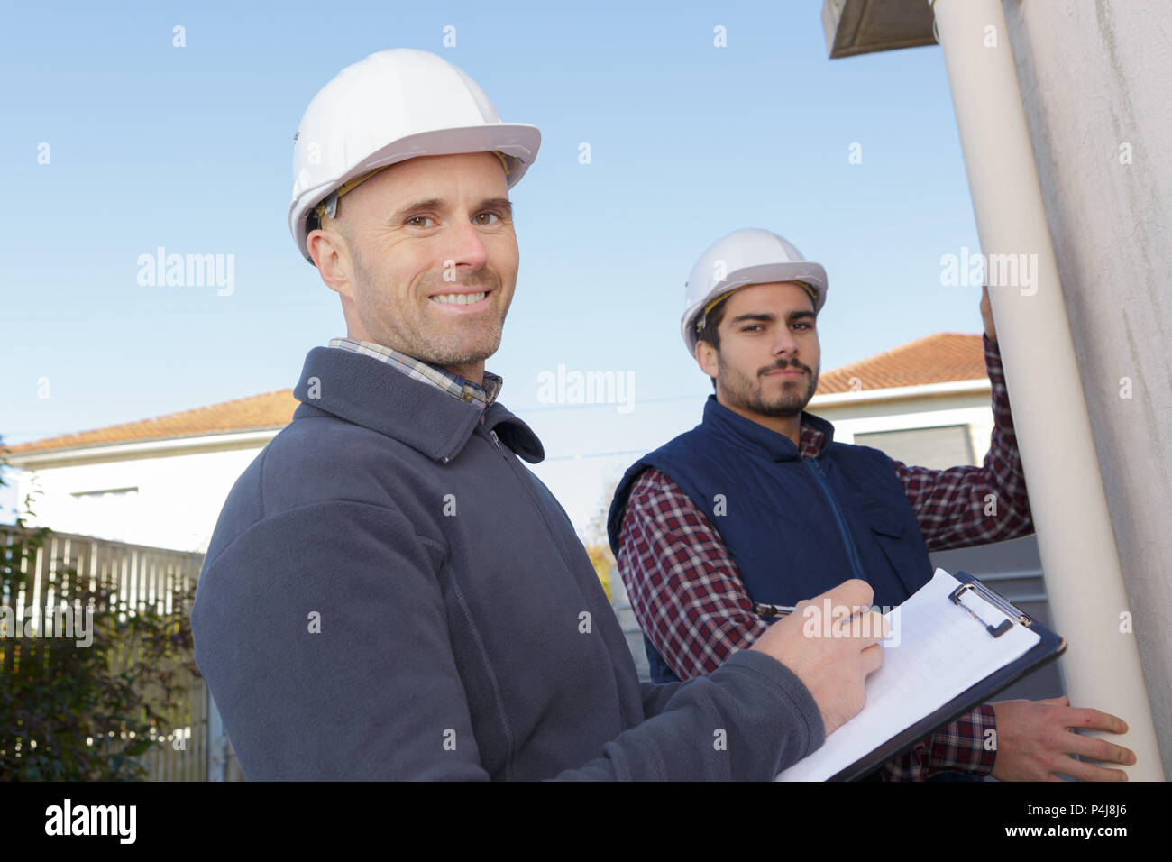 renovation manager and builder posing Stock Photo - Alamy