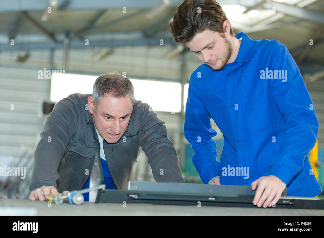 trainee learning with boss Stock Photo - Alamy