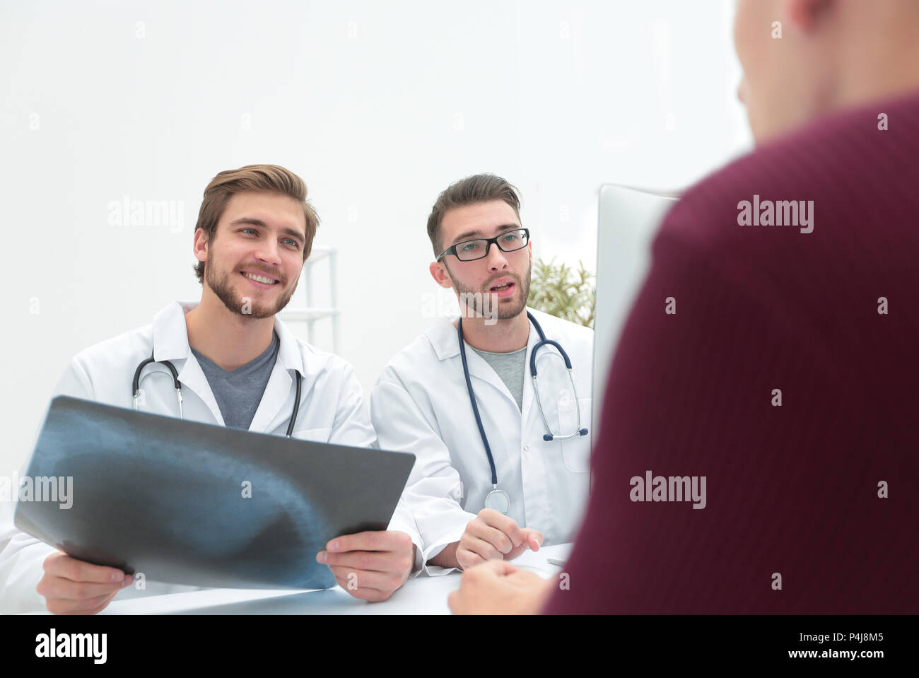 two doctors examining an x-ray of a patient Stock Photo - Alamy