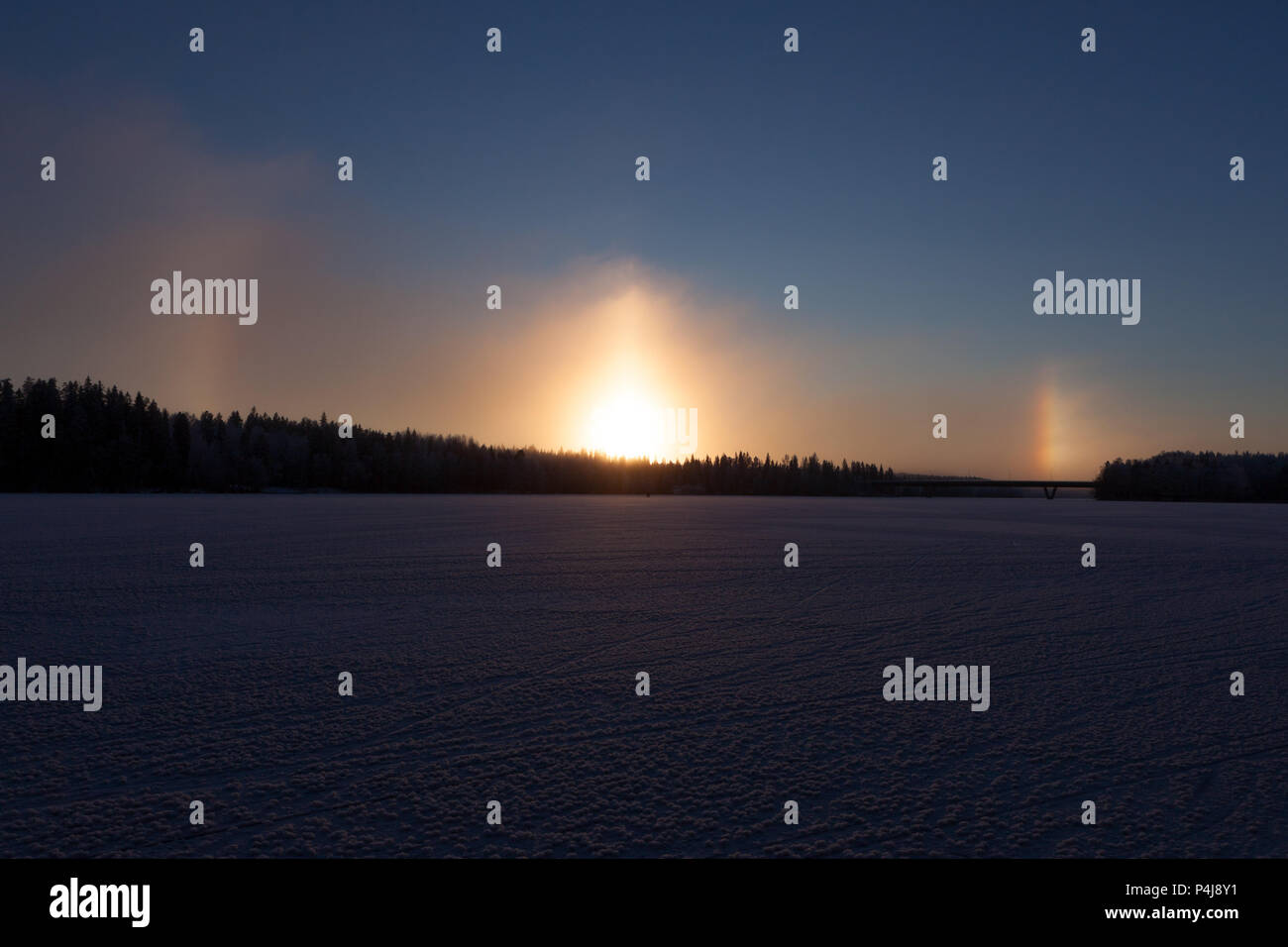 Sundogs at winter on frozen lake Stock Photo - Alamy