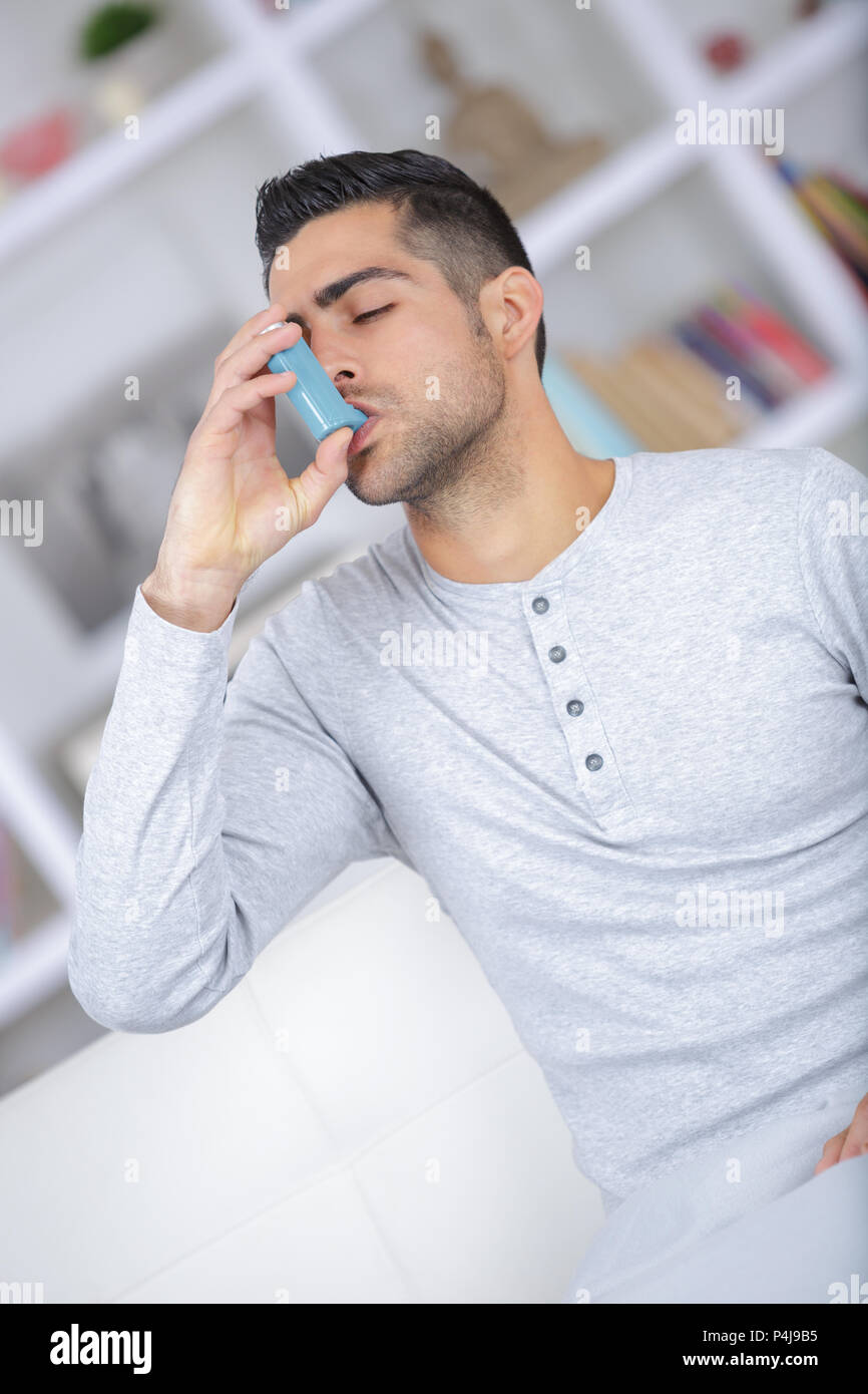 close-up of young man using asthma inhaler Stock Photo - Alamy