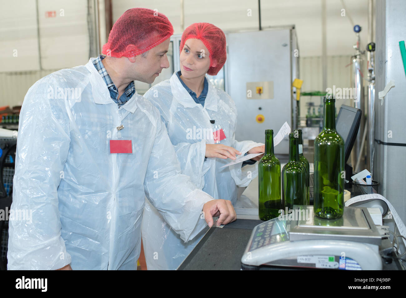 quality control of bottles against bright light Stock Photo - Alamy