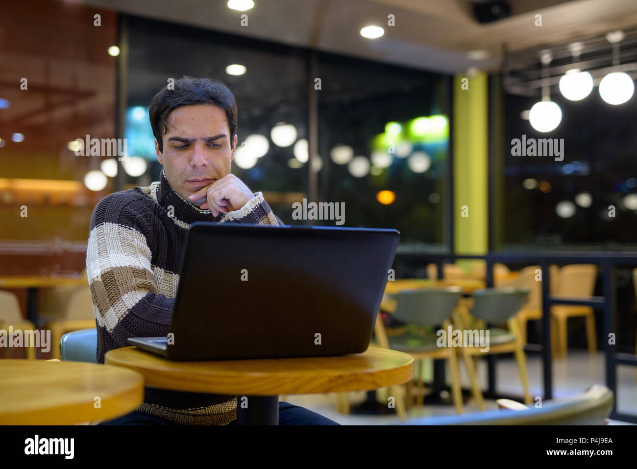 Man using laptop computer while thinking Stock Photo - Alamy