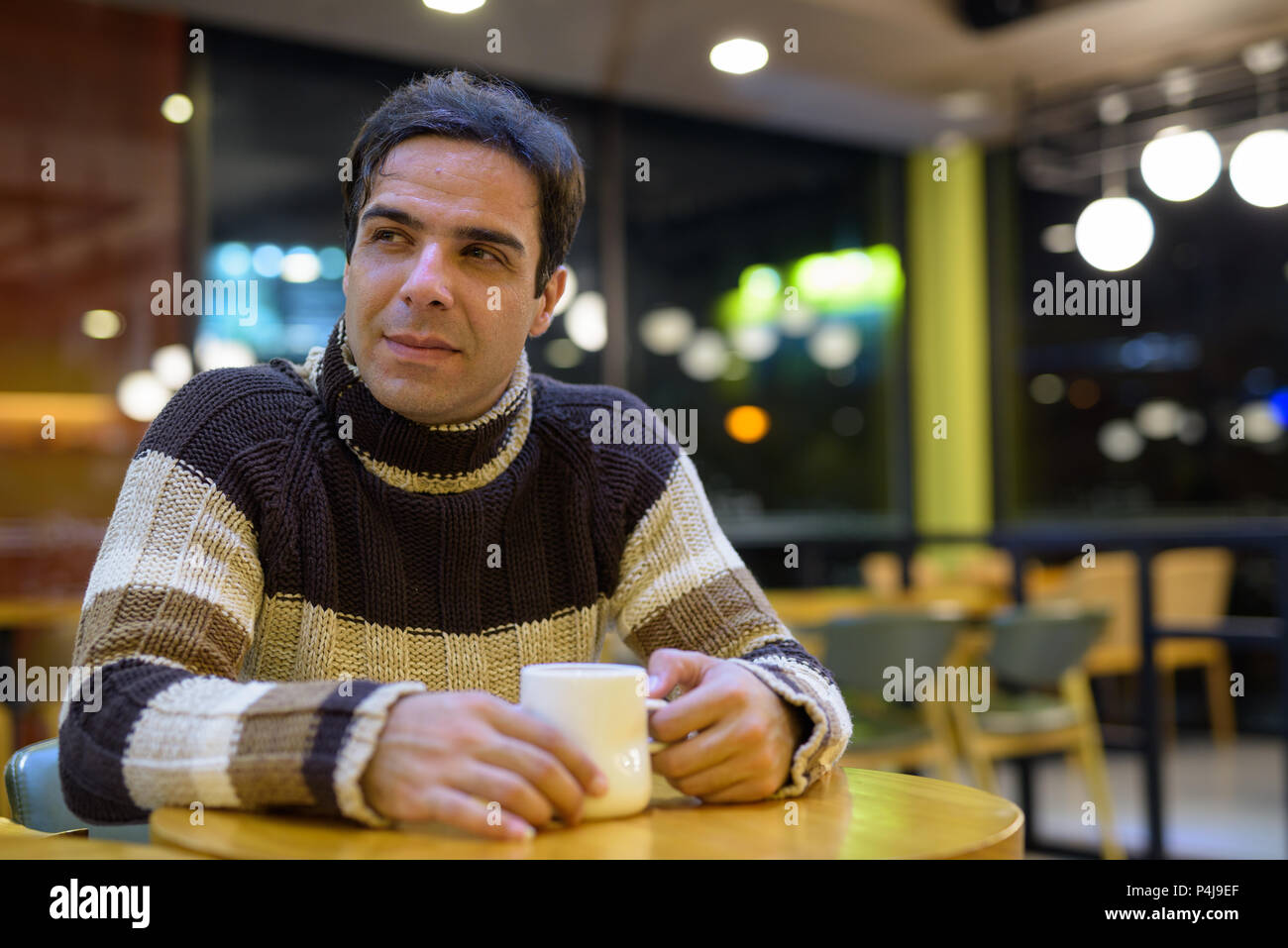 Man drinking coffee in coffee shop Stock Photo - Alamy