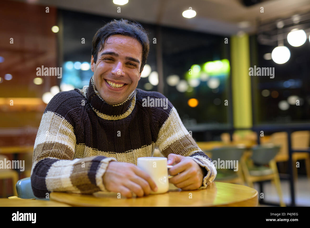 Man drinking coffee in coffee shop Stock Photo - Alamy