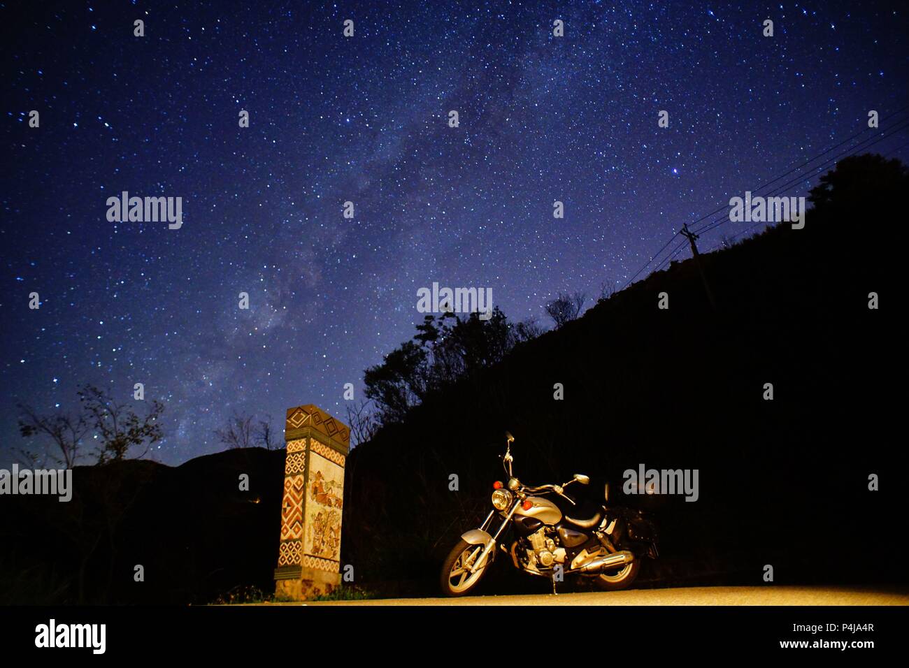 motorcycle stand by the Stele under starry sky Stock Photo - Alamy