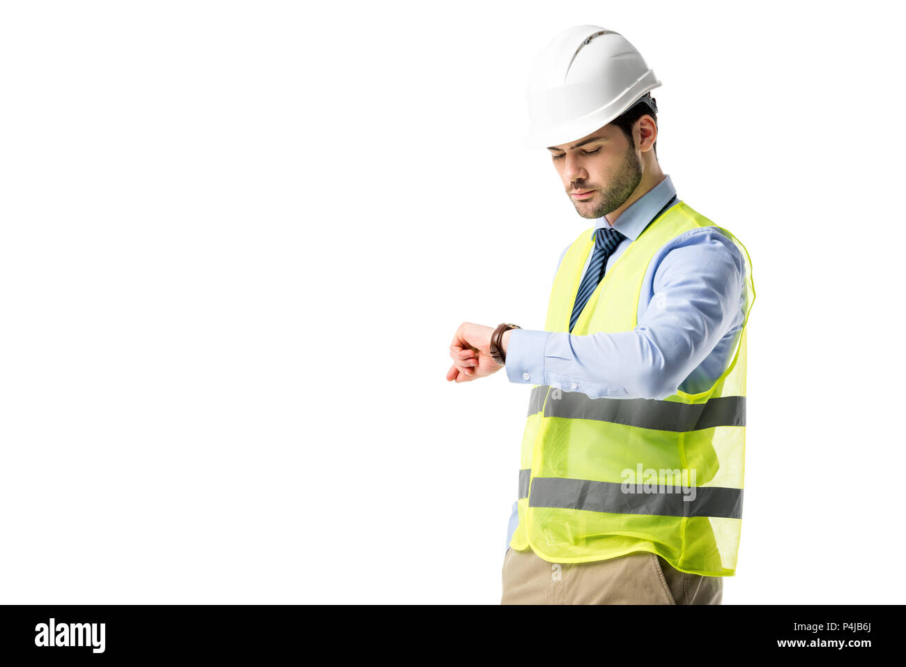 Construction worker in reflective vest checking his watch isolated on ...